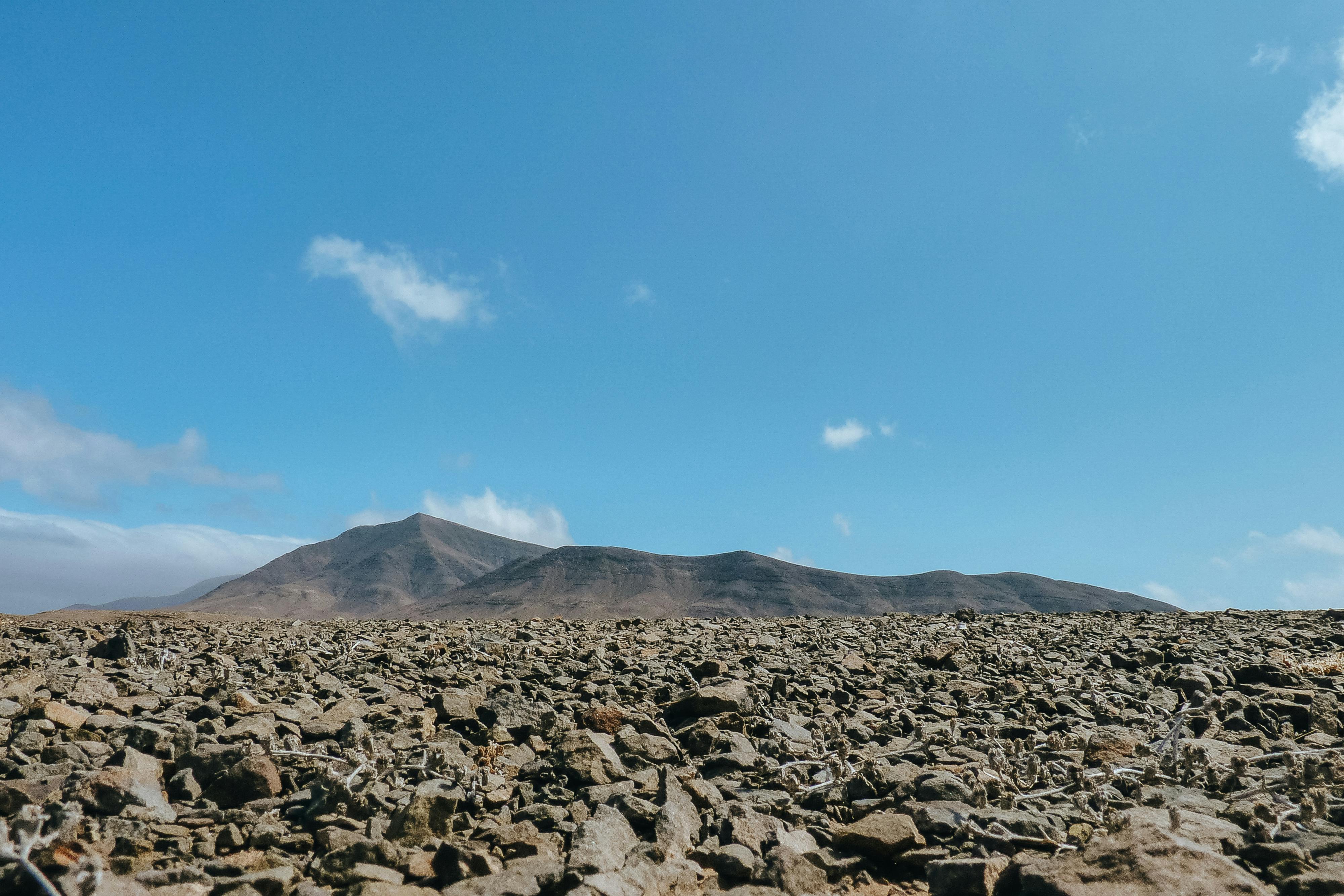 Astronauts Holding Hands on a Desolate Planet · Free Stock Photo