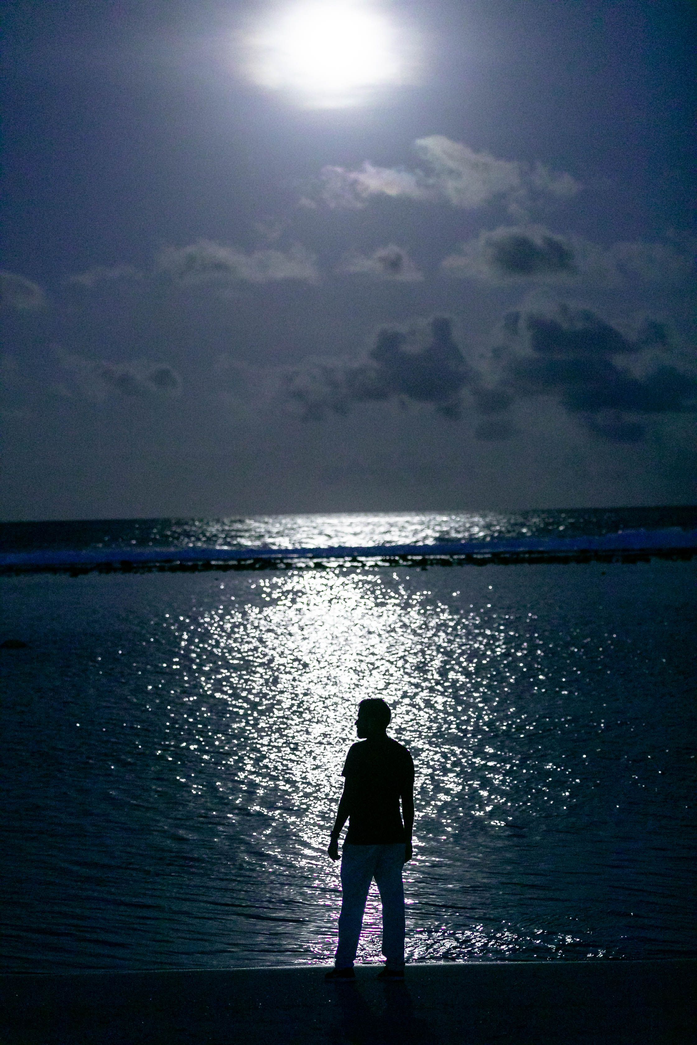 Silhouette of a Man Standing Near the Ocean · Free Stock Photo