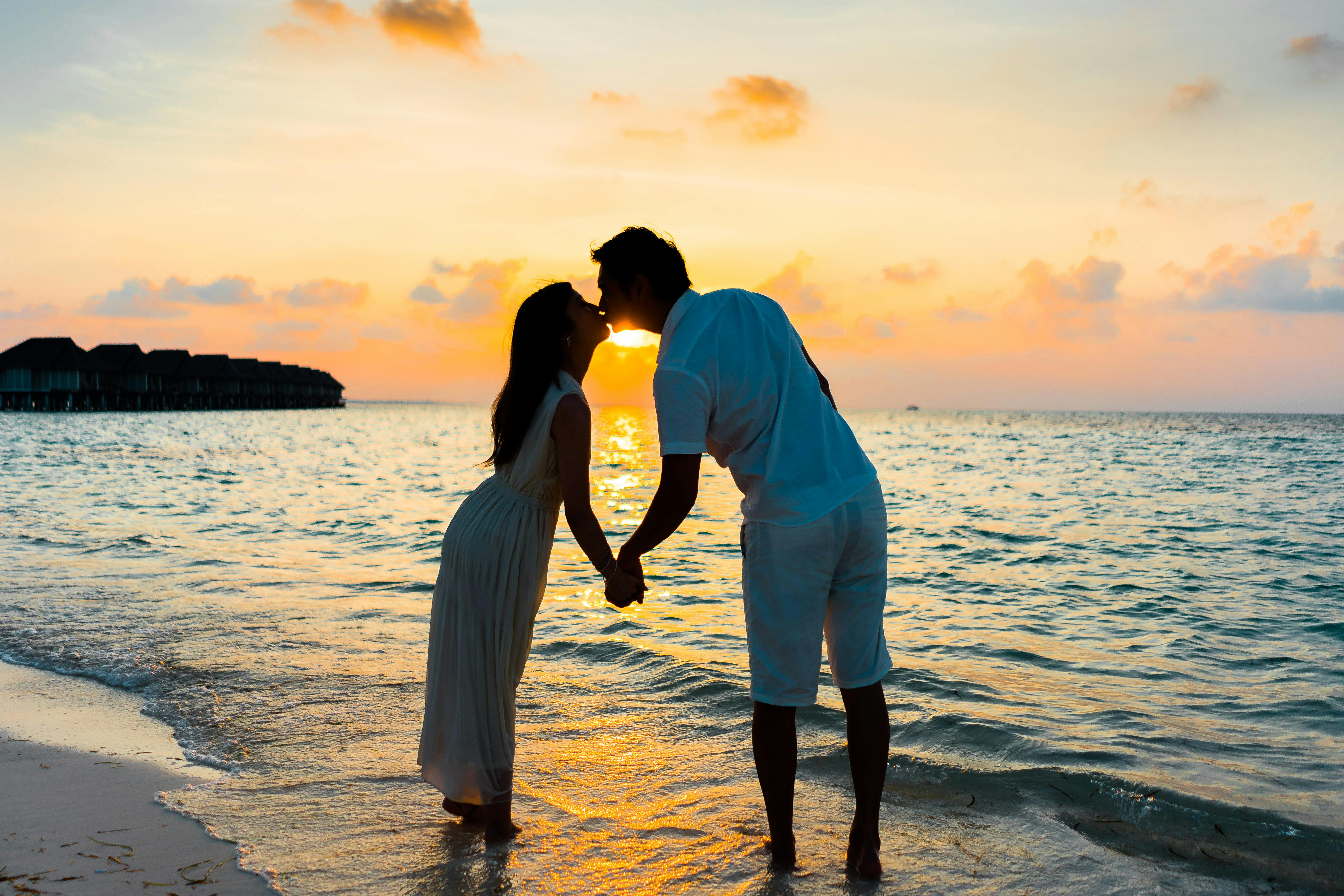 A Couple Kissing at the Beach · Free Stock Photo
