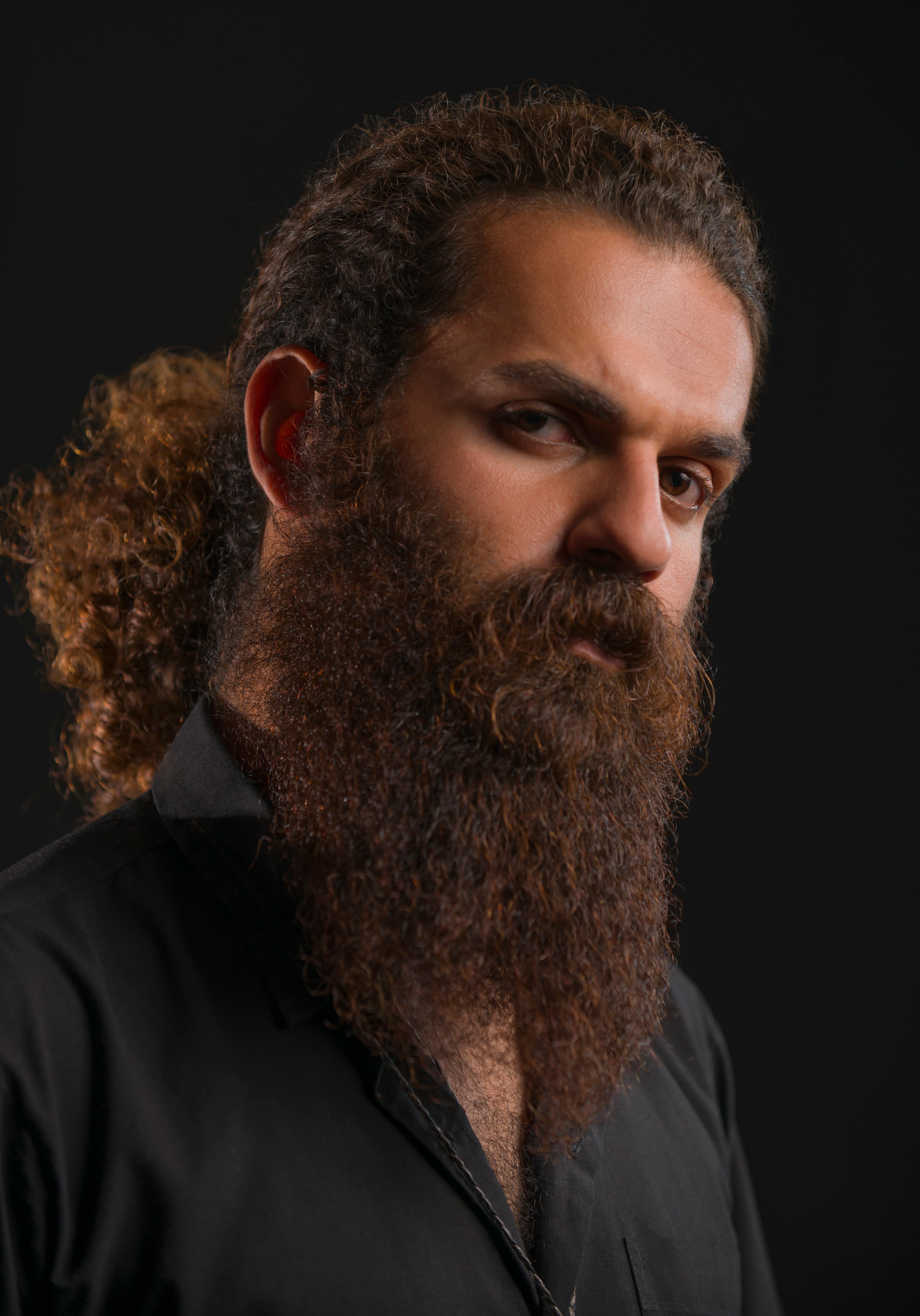 Profile Studio Shoot of a Man Posing against Orange Brown Background ...