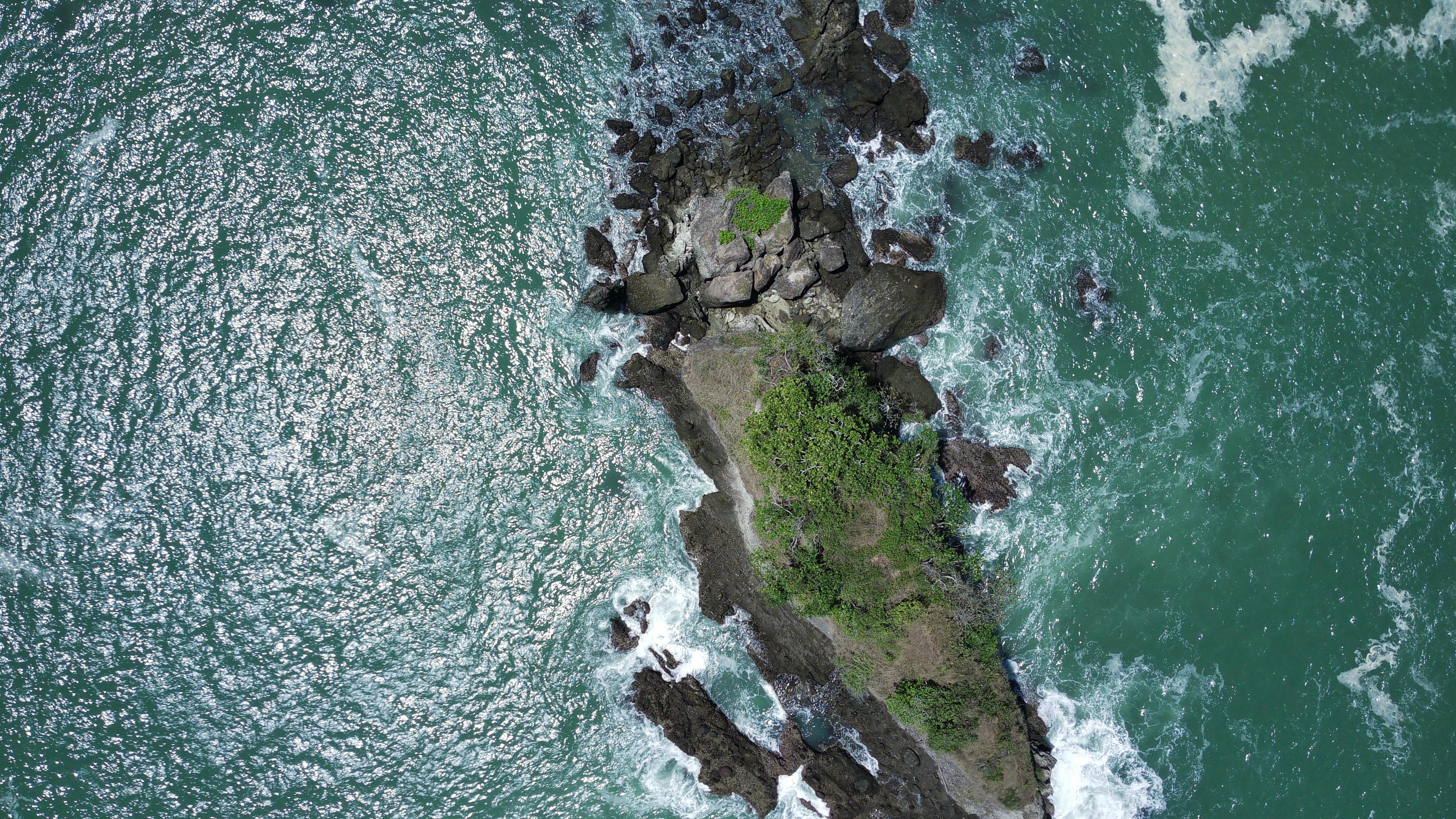 Aerial View of Island Shore by Turquoise Sea · Free Stock Photo