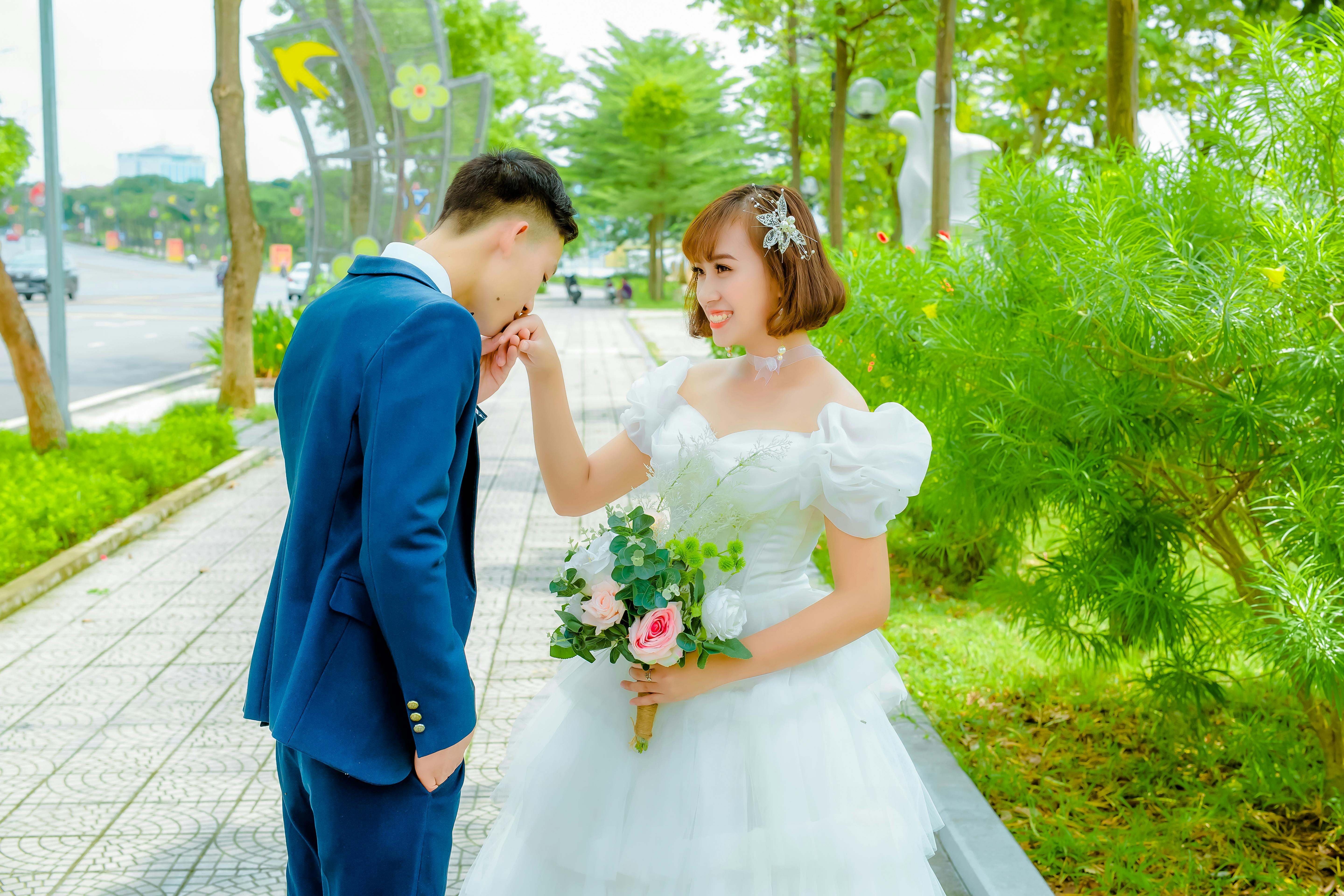 Man in Blue Suit Jacket Kissing Woman's Hand · Free Stock Photo