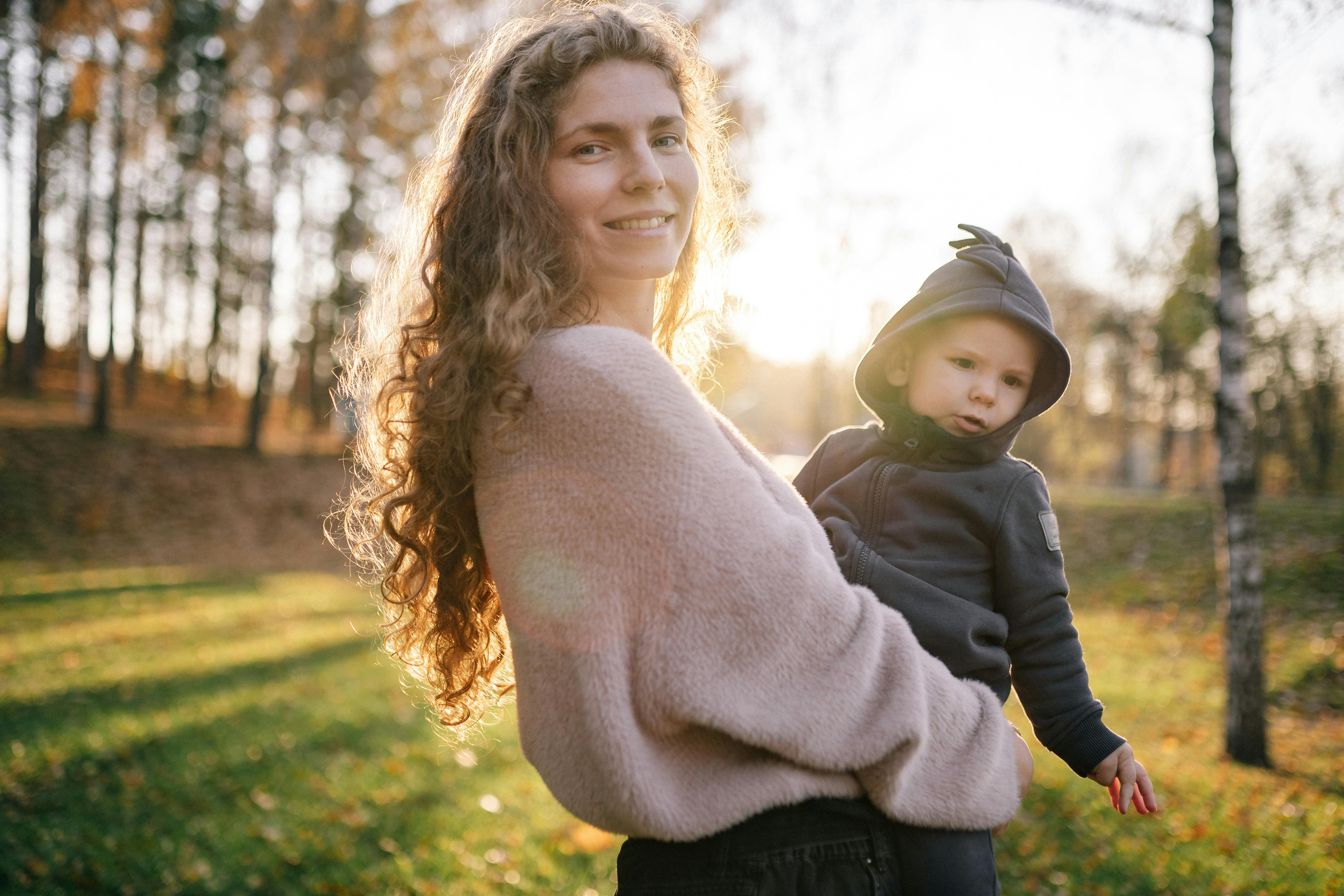 A Woman Carrying a Baby · Free Stock Photo