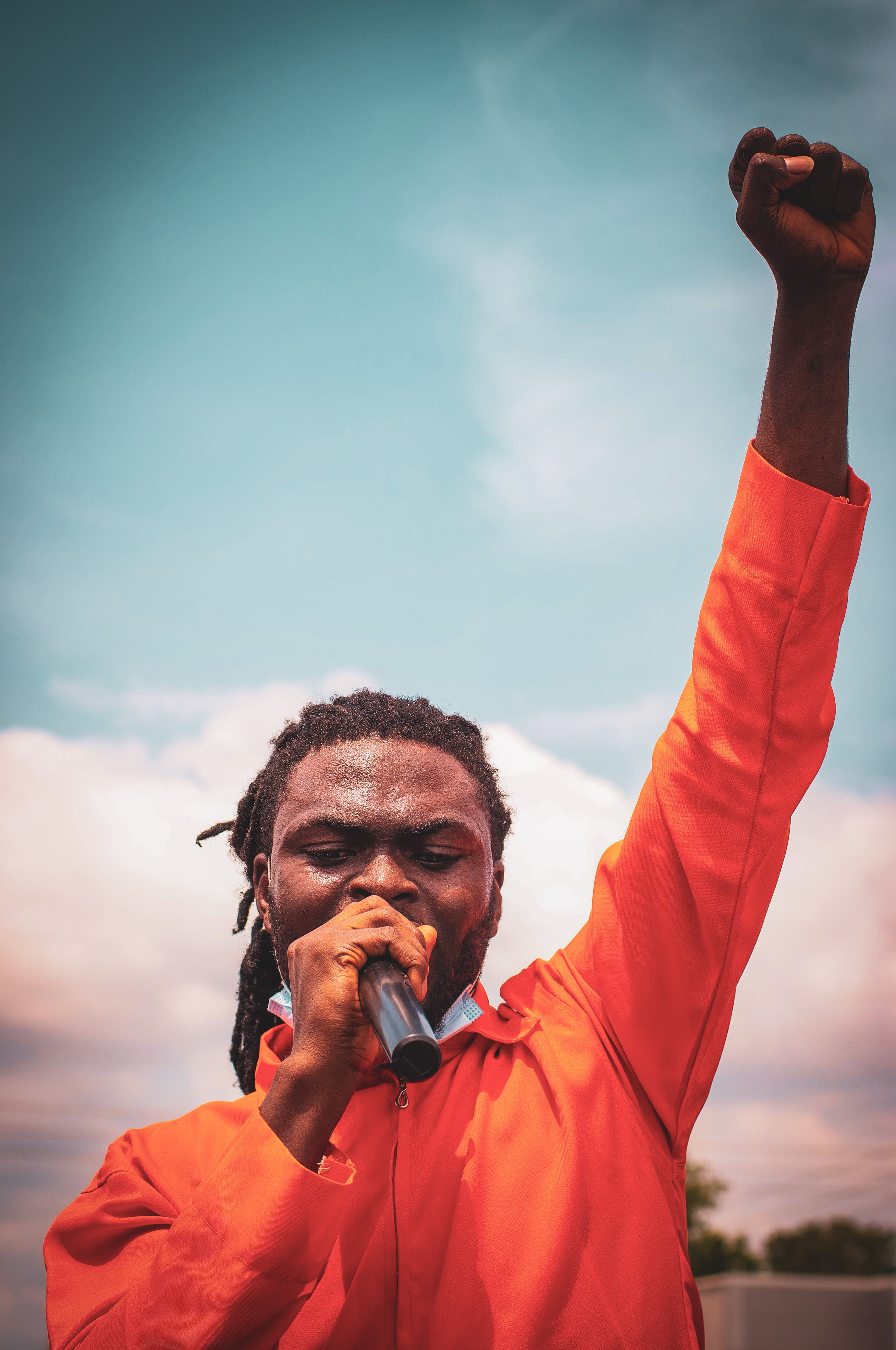 Man in Orange Jacket Holding Microphone · Free Stock Photo
