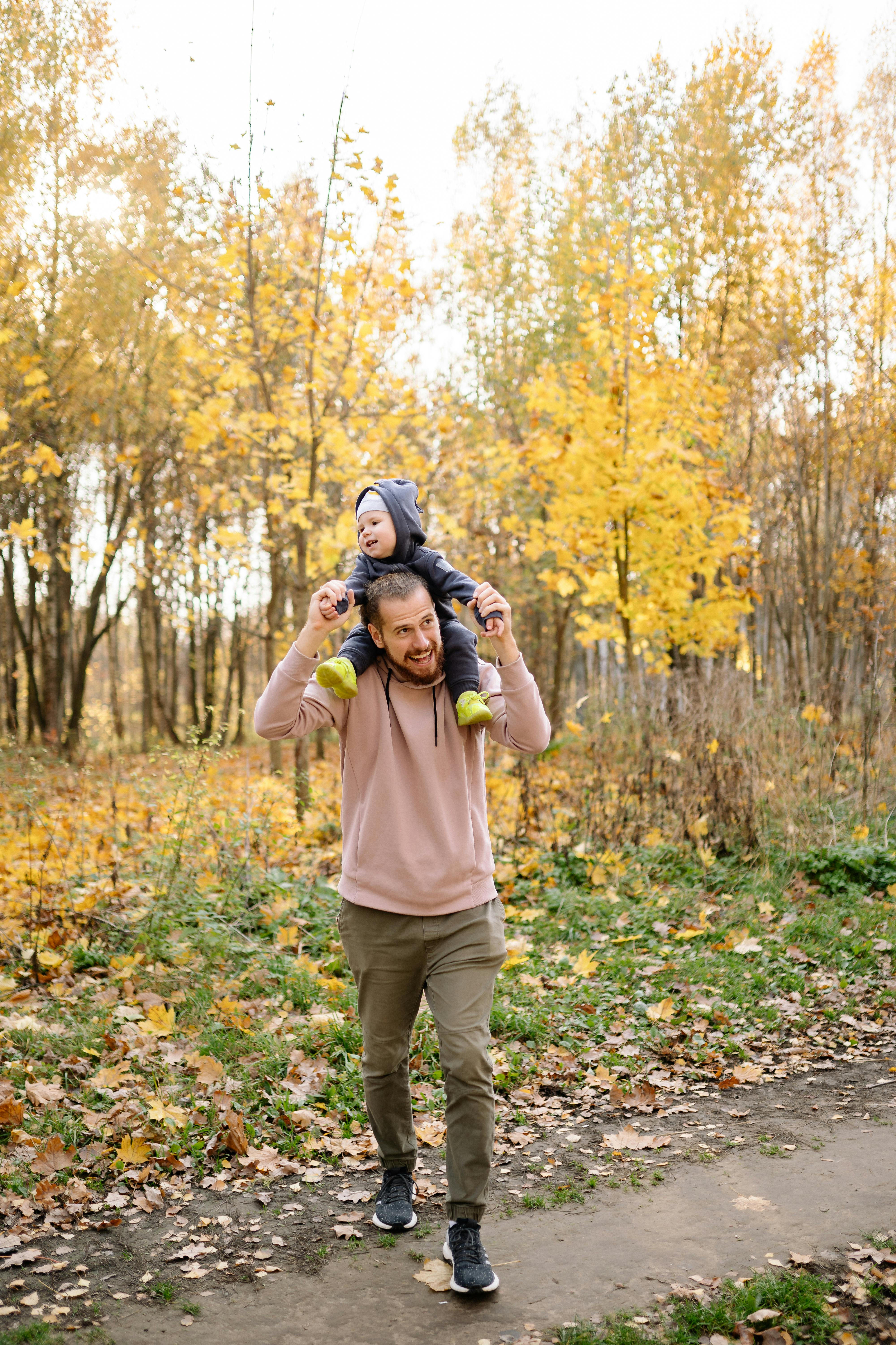 A Man Carrying His Child · Free Stock Photo