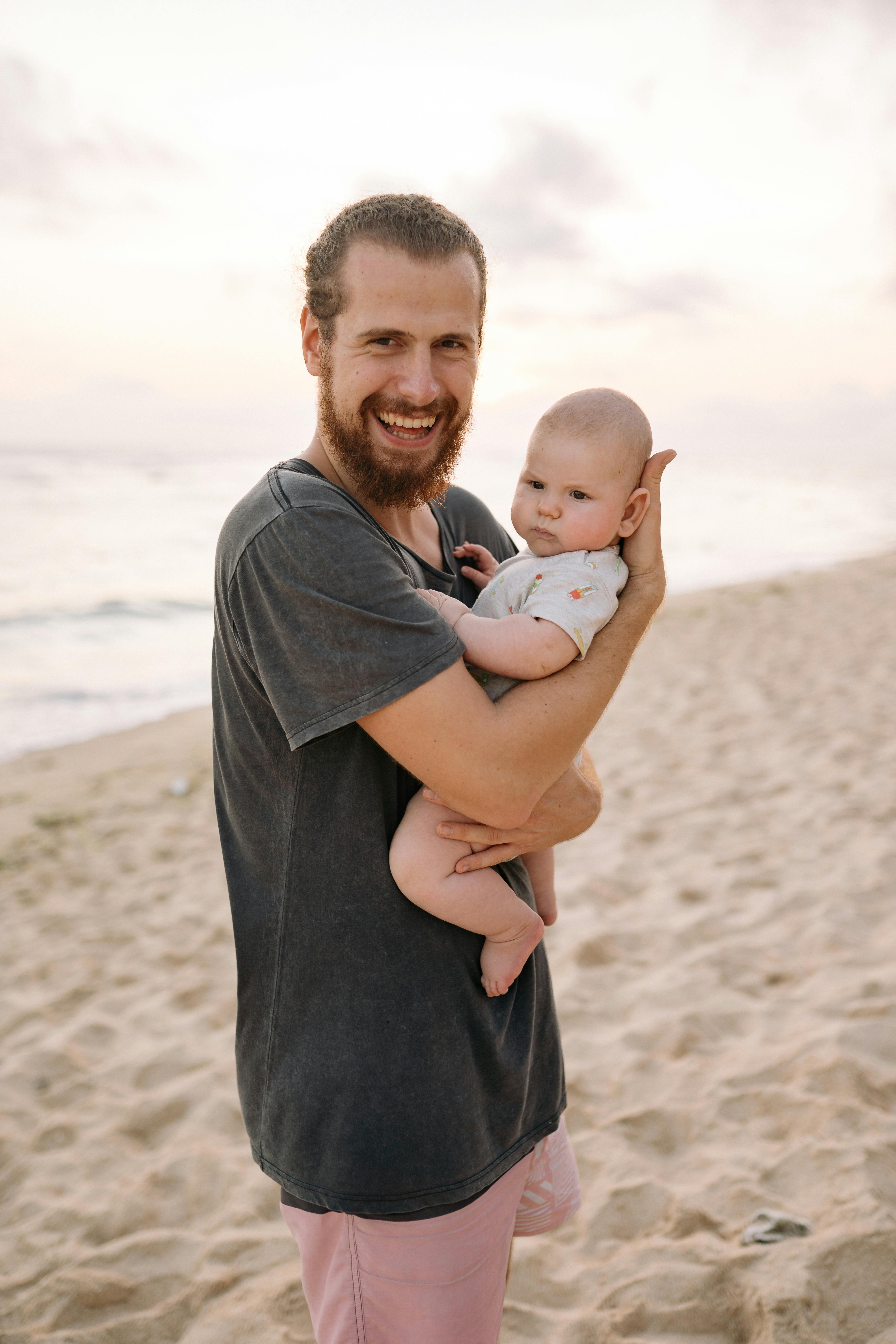 A Man Carrying His Baby · Free Stock Photo