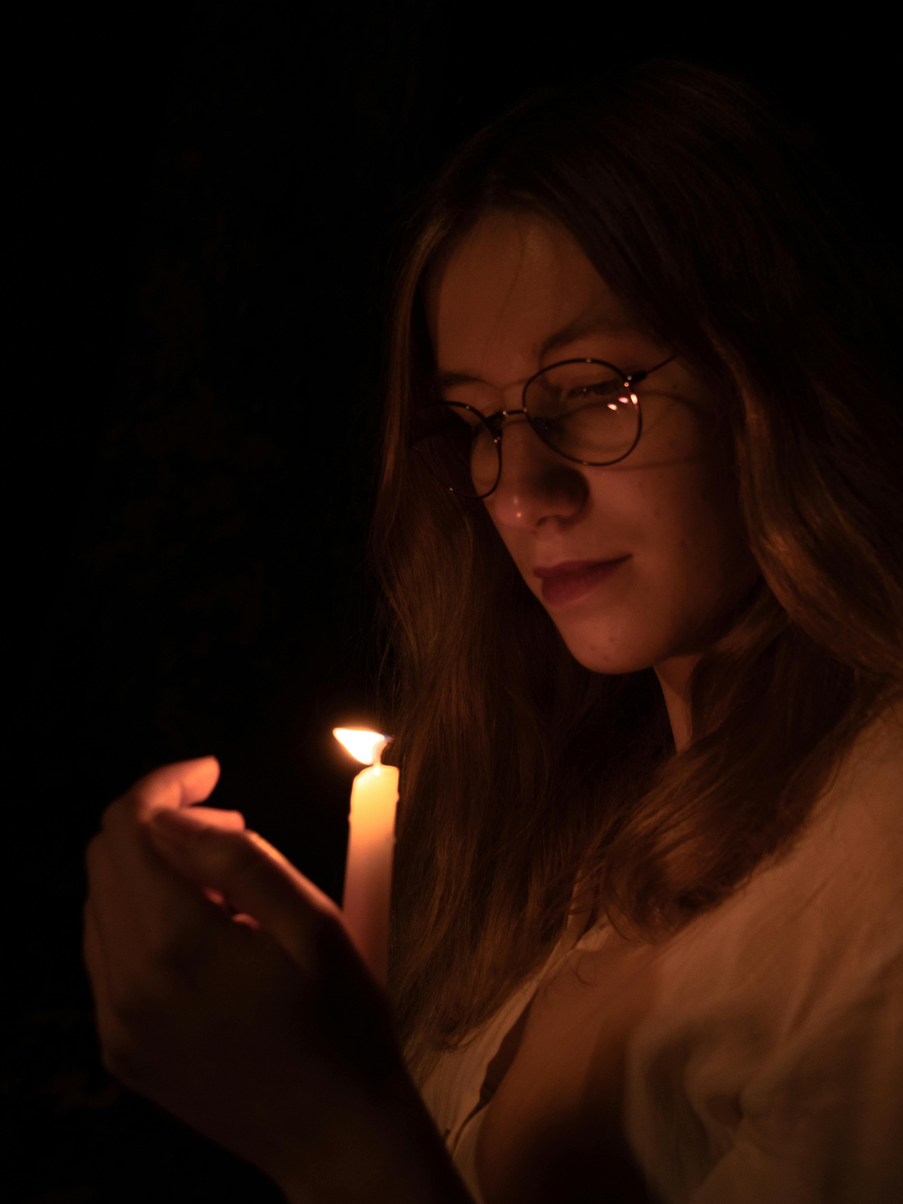 A Woman Holding a Burning Candle · Free Stock Photo