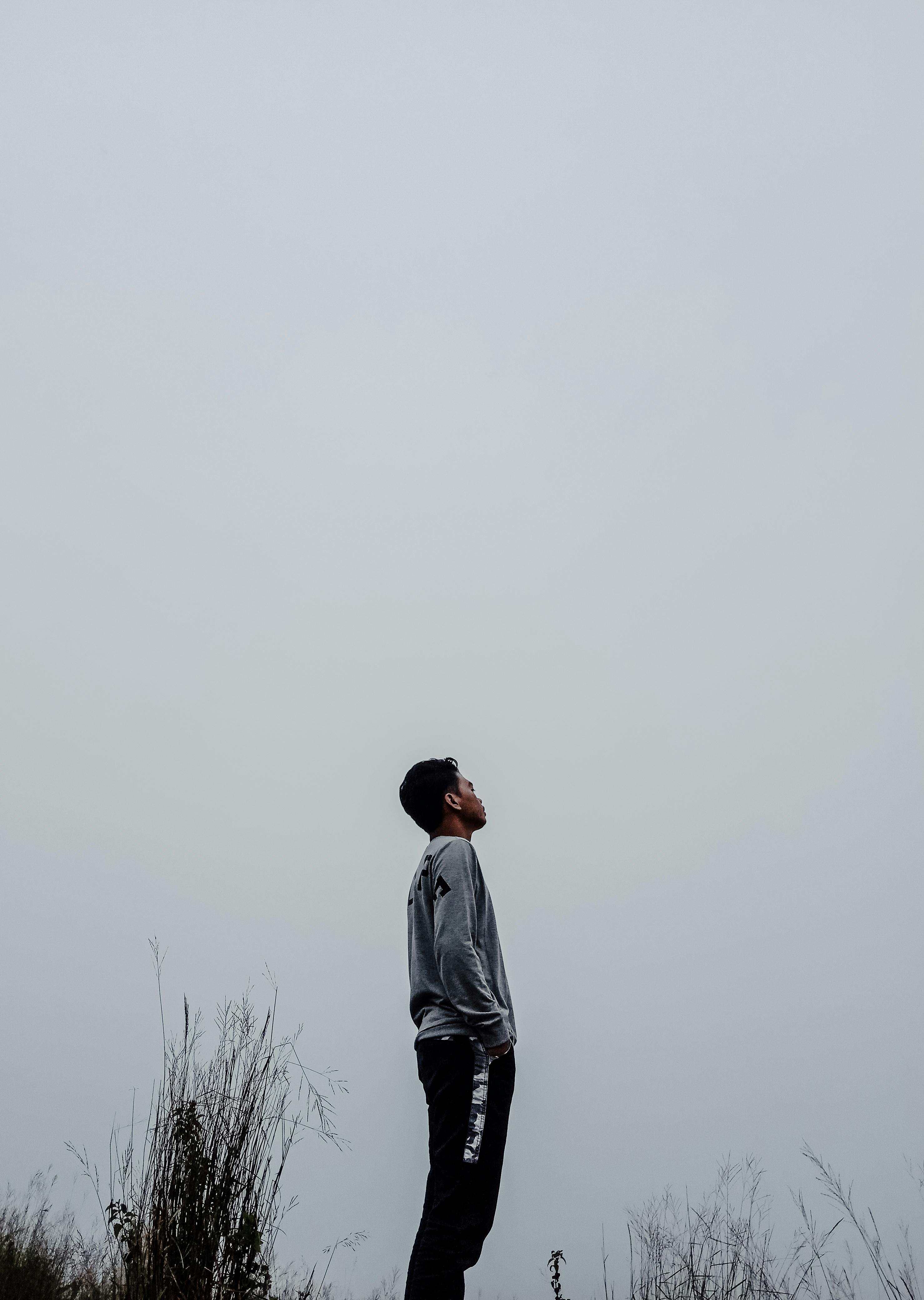 Man Standing near Fence on City Terrace · Free Stock Photo