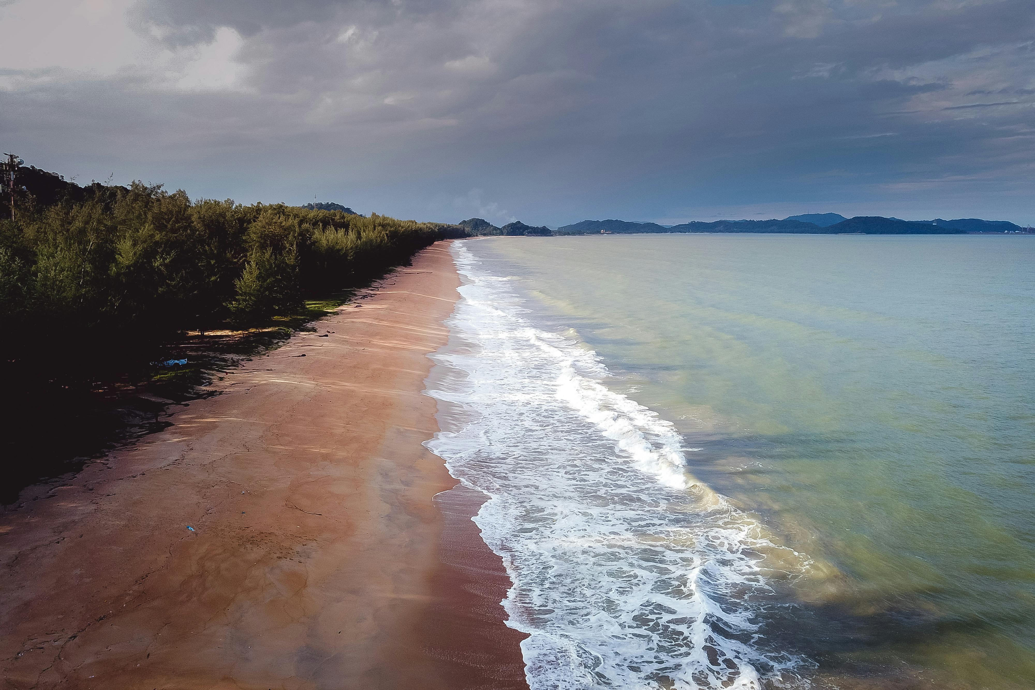 Stormy sea water near sandy shore · Free Stock Photo