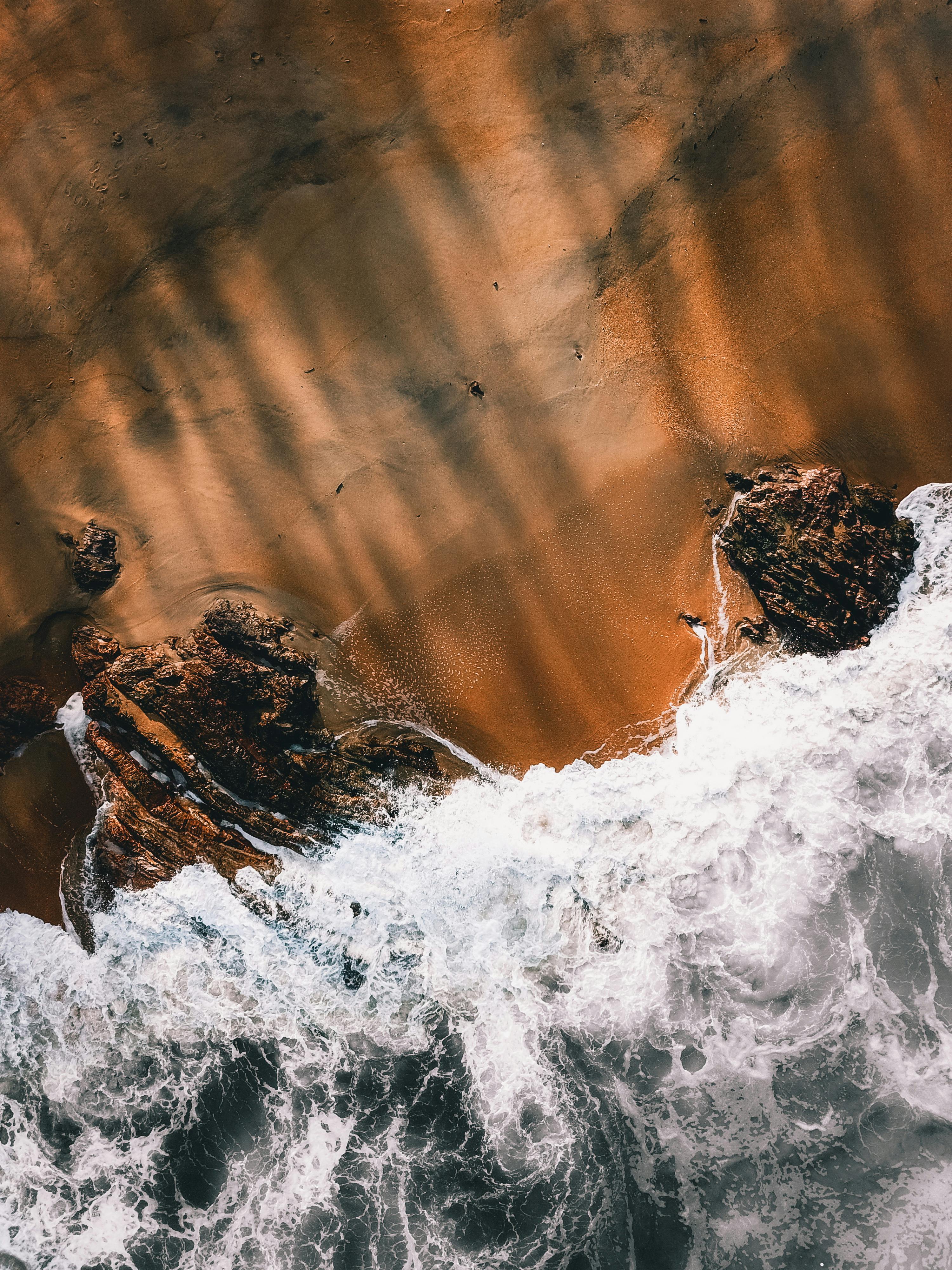 Sandy ground with seashells and stones · Free Stock Photo