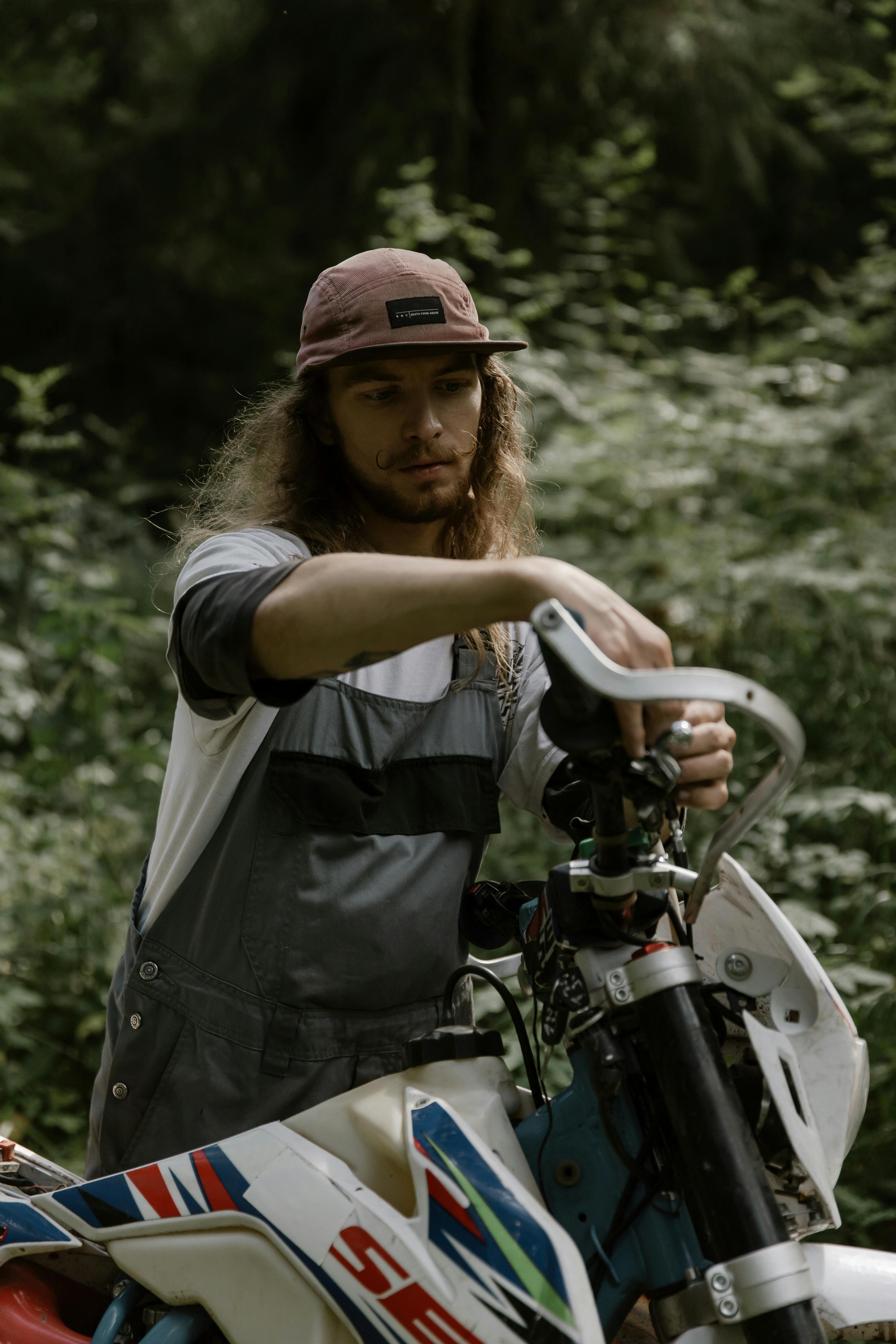 Man fixing his Motocross Dirt Bike · Free Stock Photo