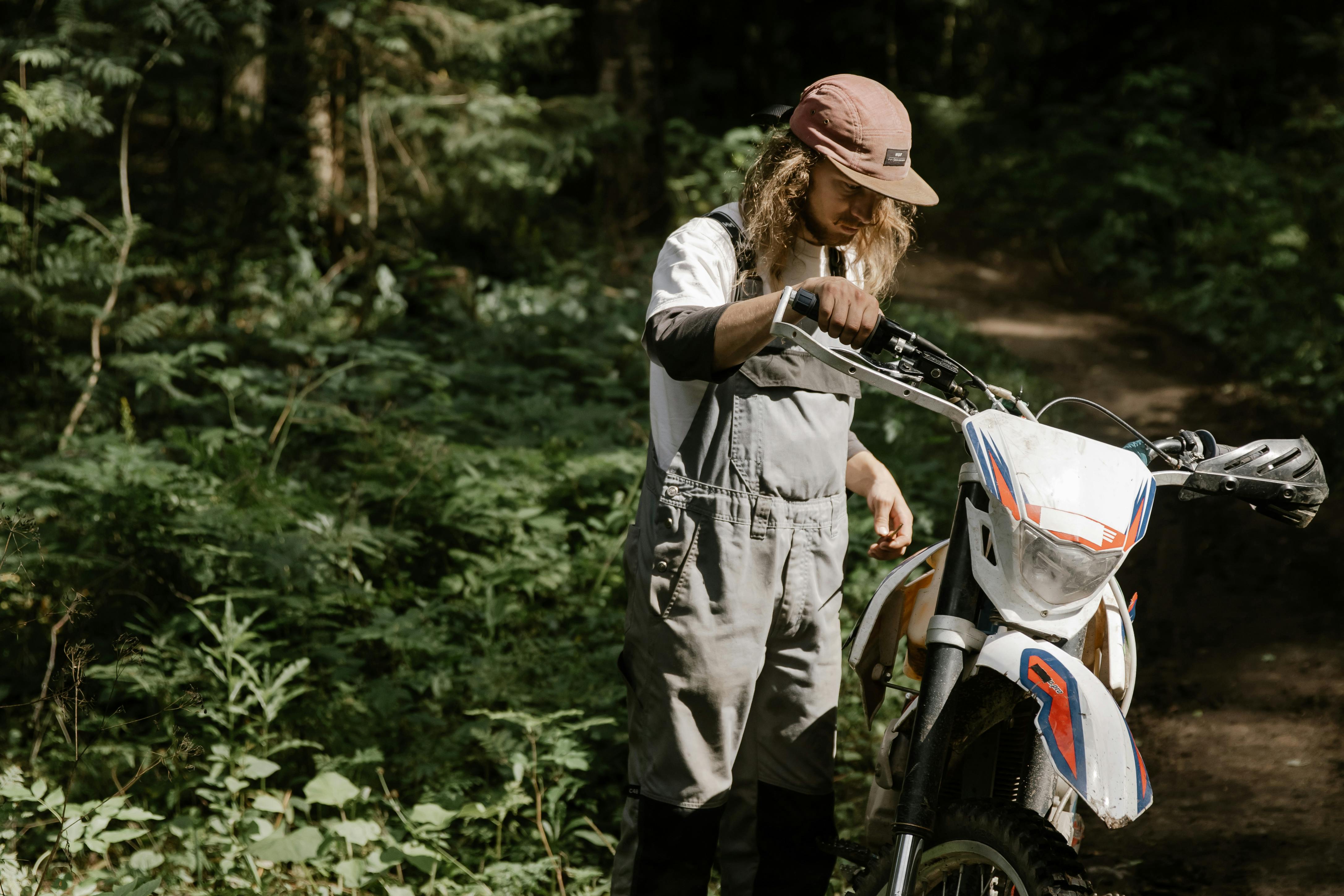 Man Standing Beside a Motorcycle · Free Stock Photo