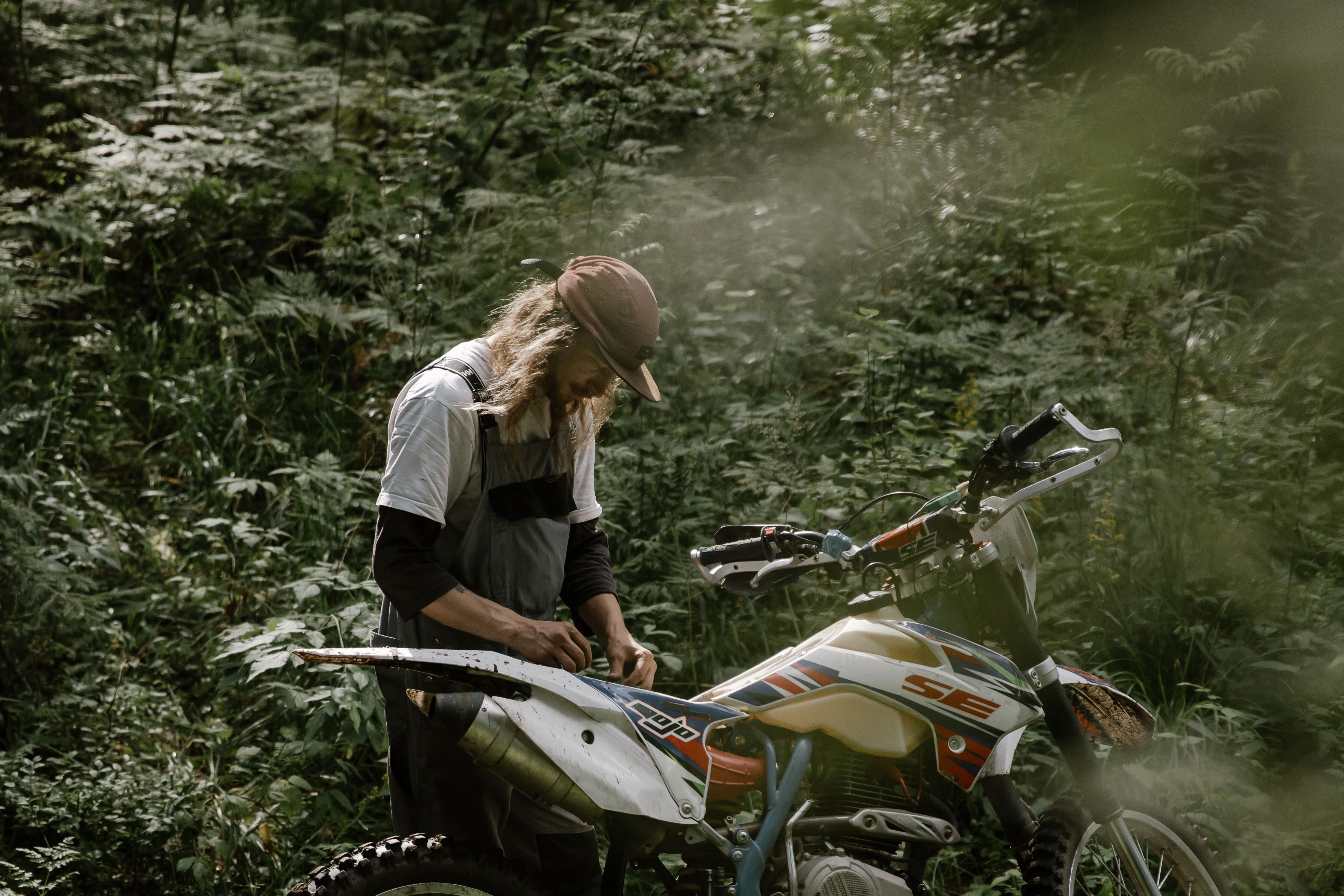 Man Checking the Bike Tire · Free Stock Photo