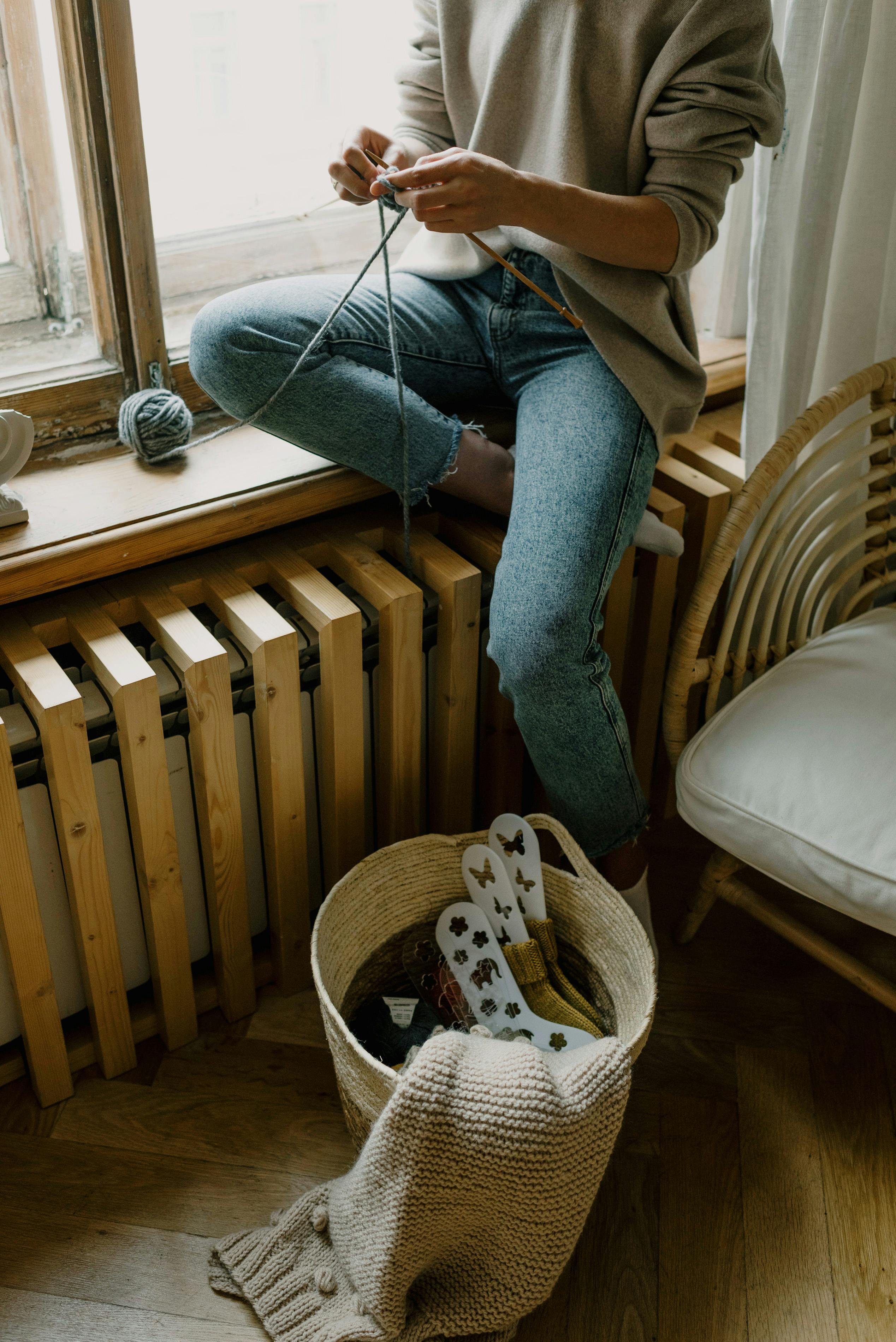 Person sitting on Window Pane Knitting · Free Stock Photo