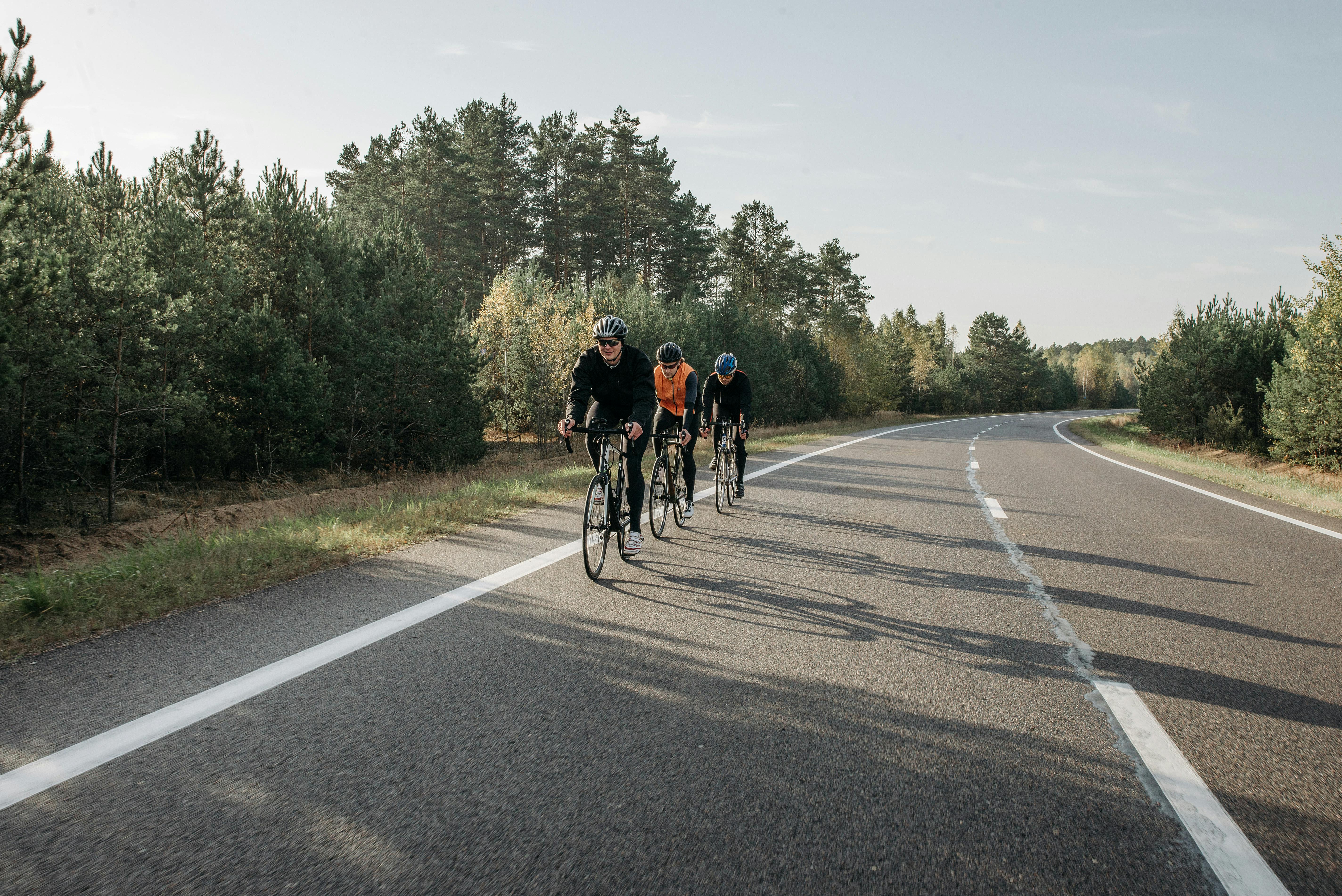 Three People Biking on the Road · Free Stock Photo