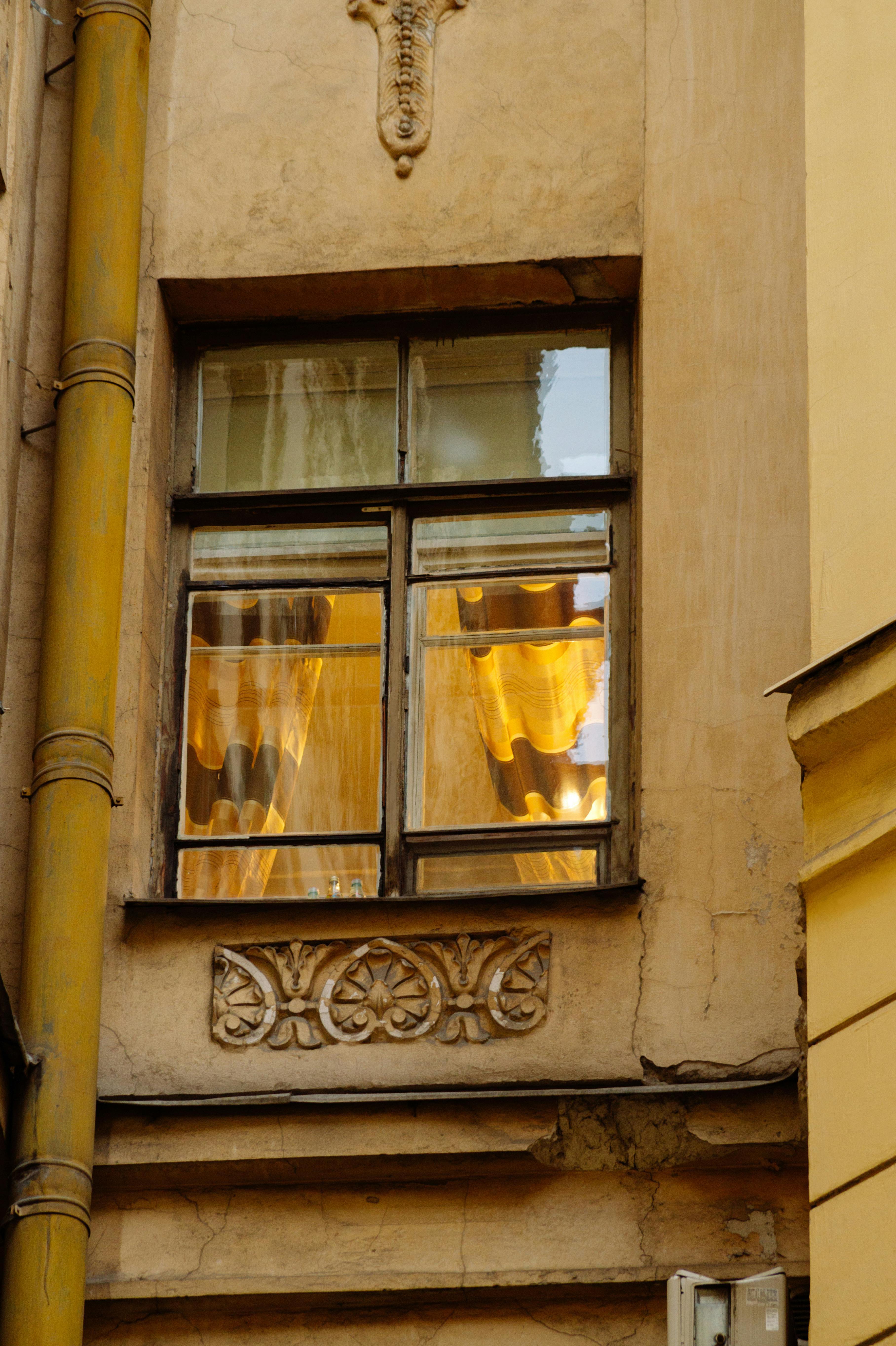 Old building with balconies and arched passage · Free Stock Photo