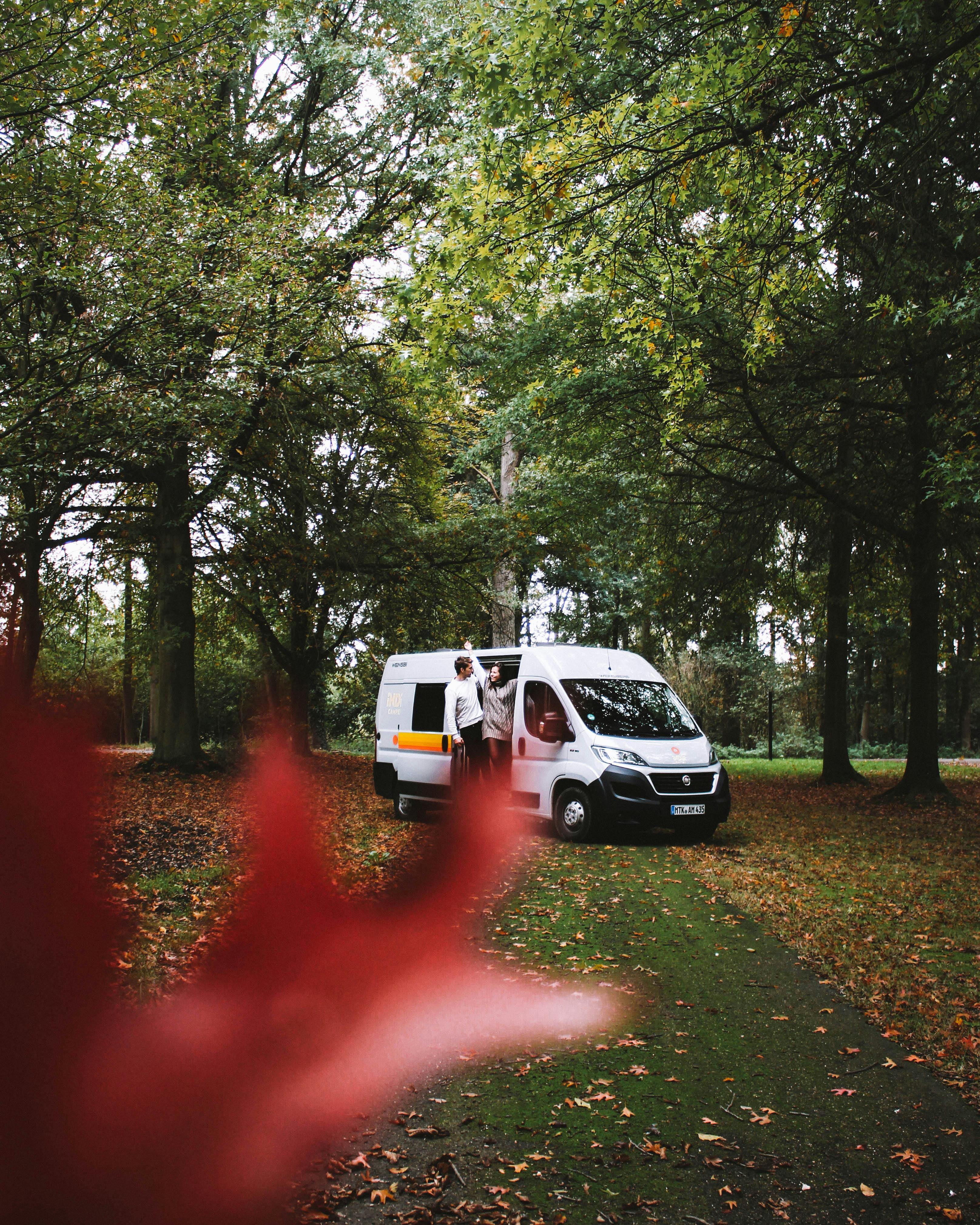 White Van Parked Under a Tree · Free Stock Photo