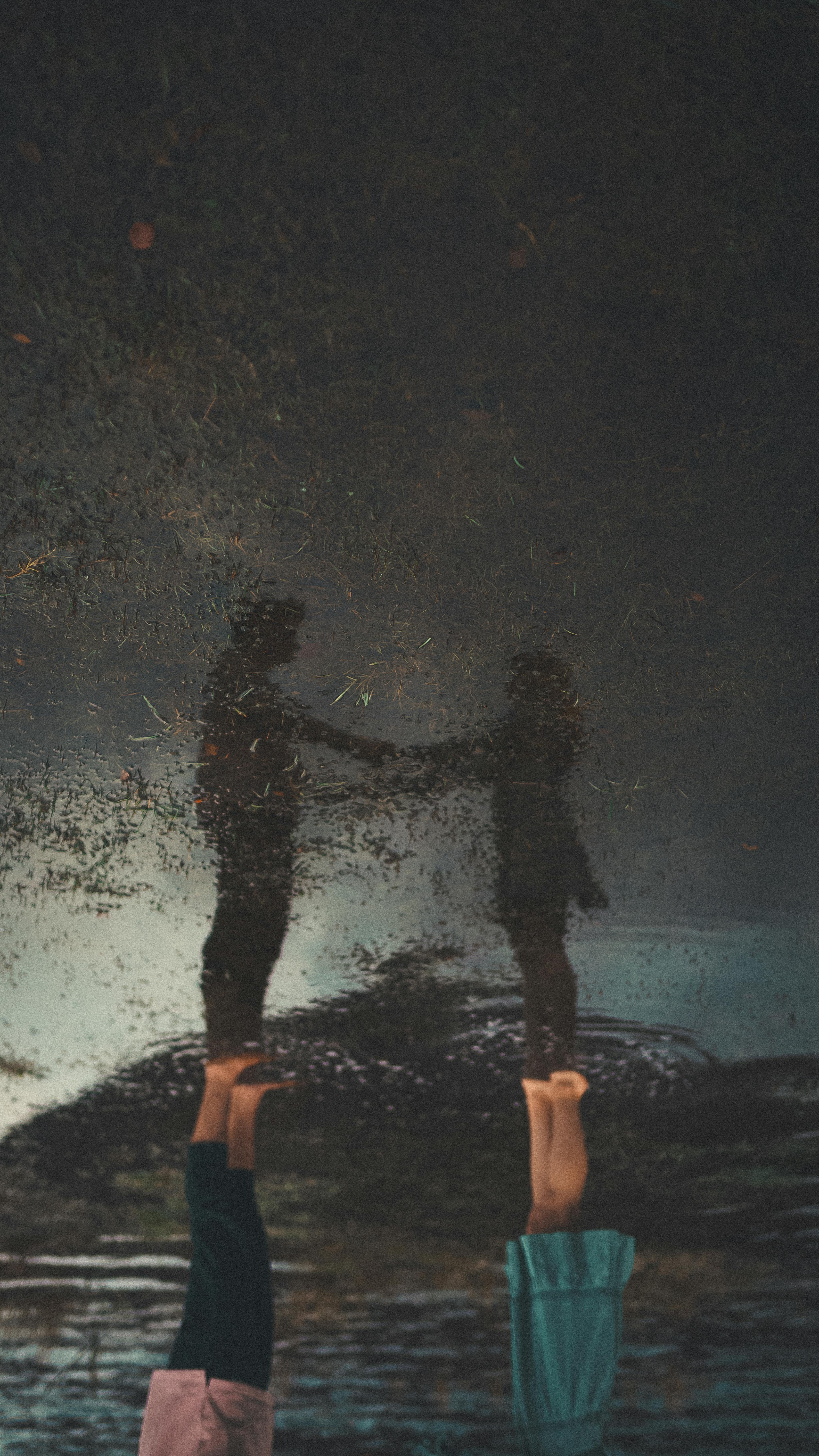 Crop couple in reflection of water · Free Stock Photo