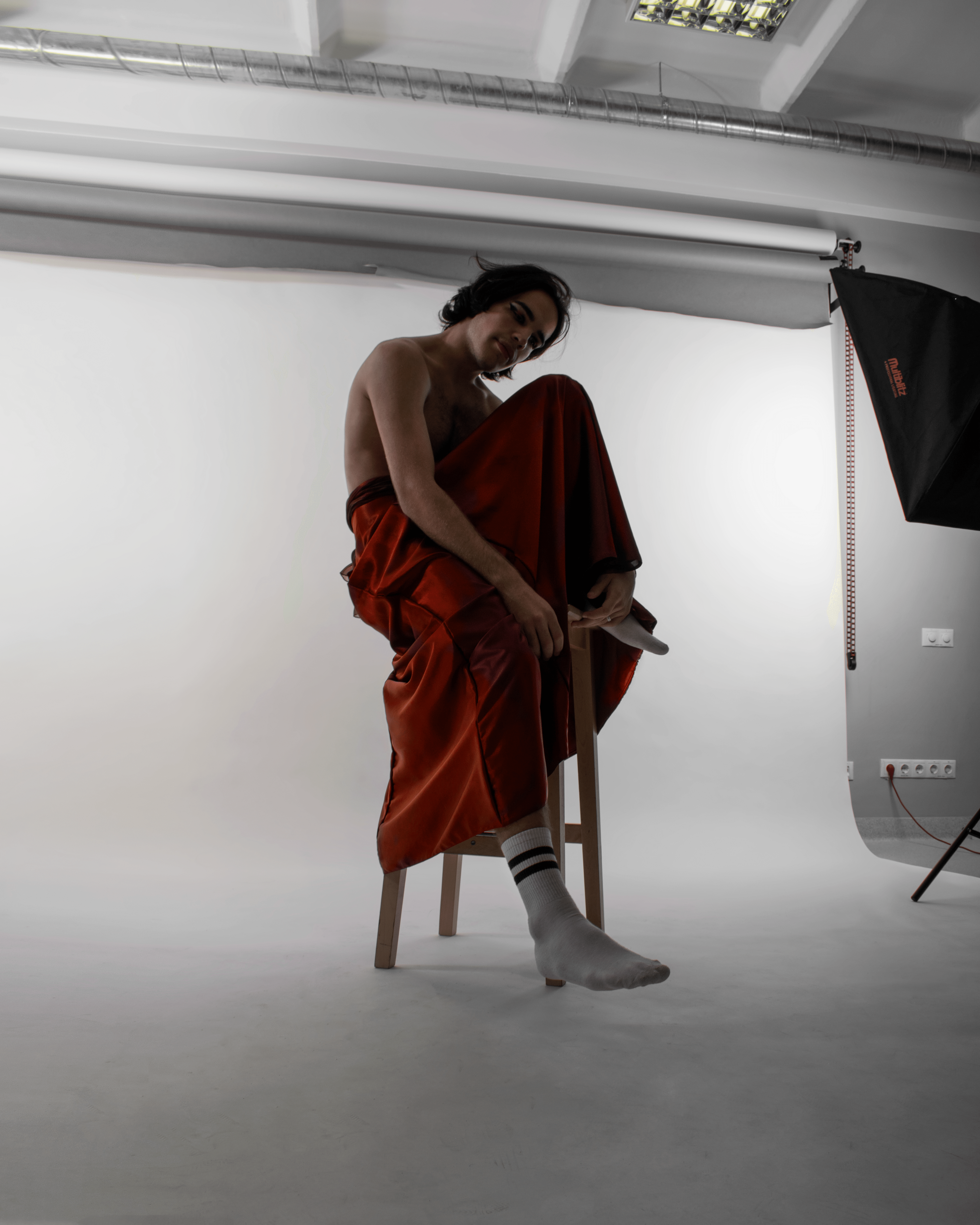 A Male Model Reclining on a Stool · Free Stock Photo