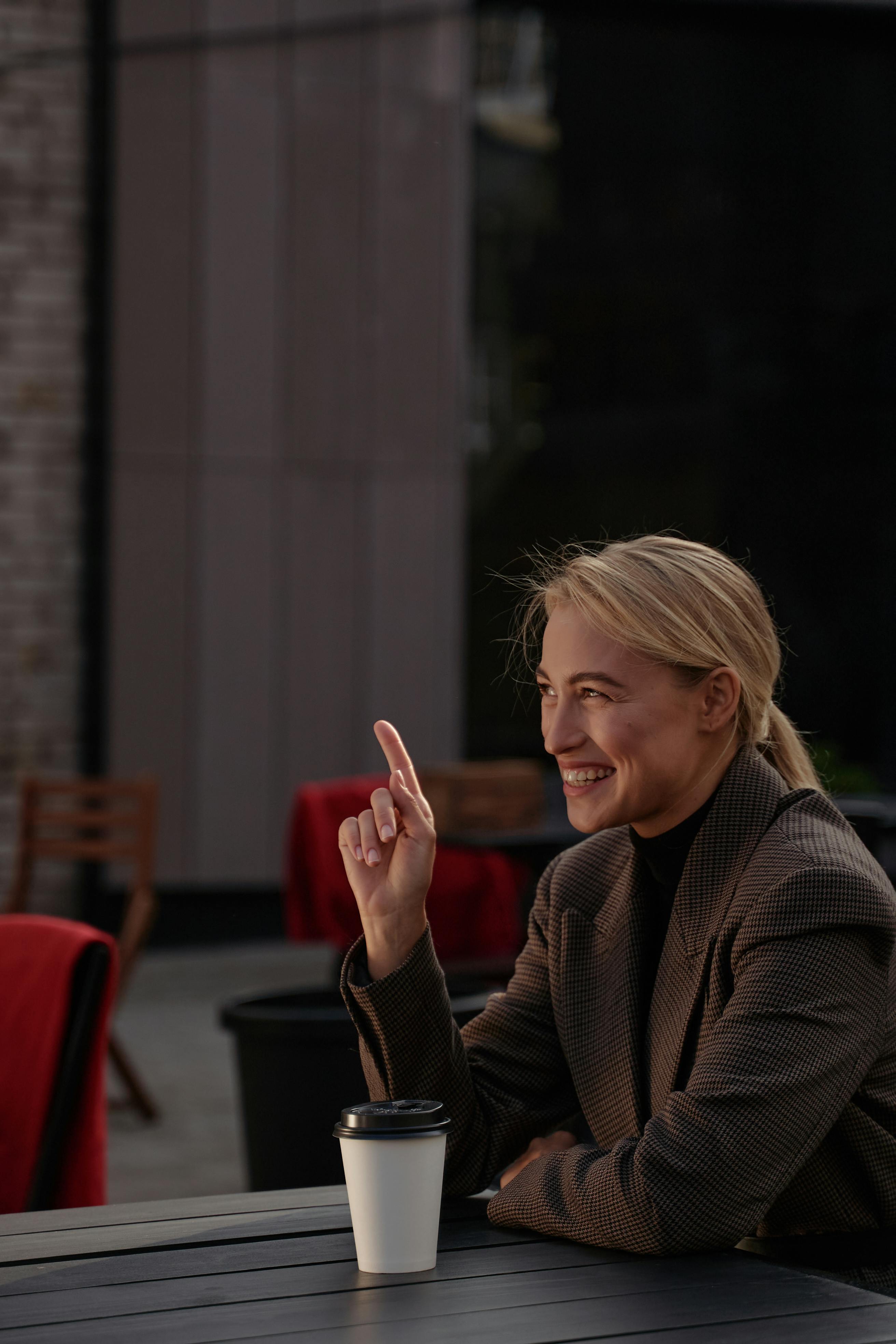 A Woman Sitting at the Table · Free Stock Photo