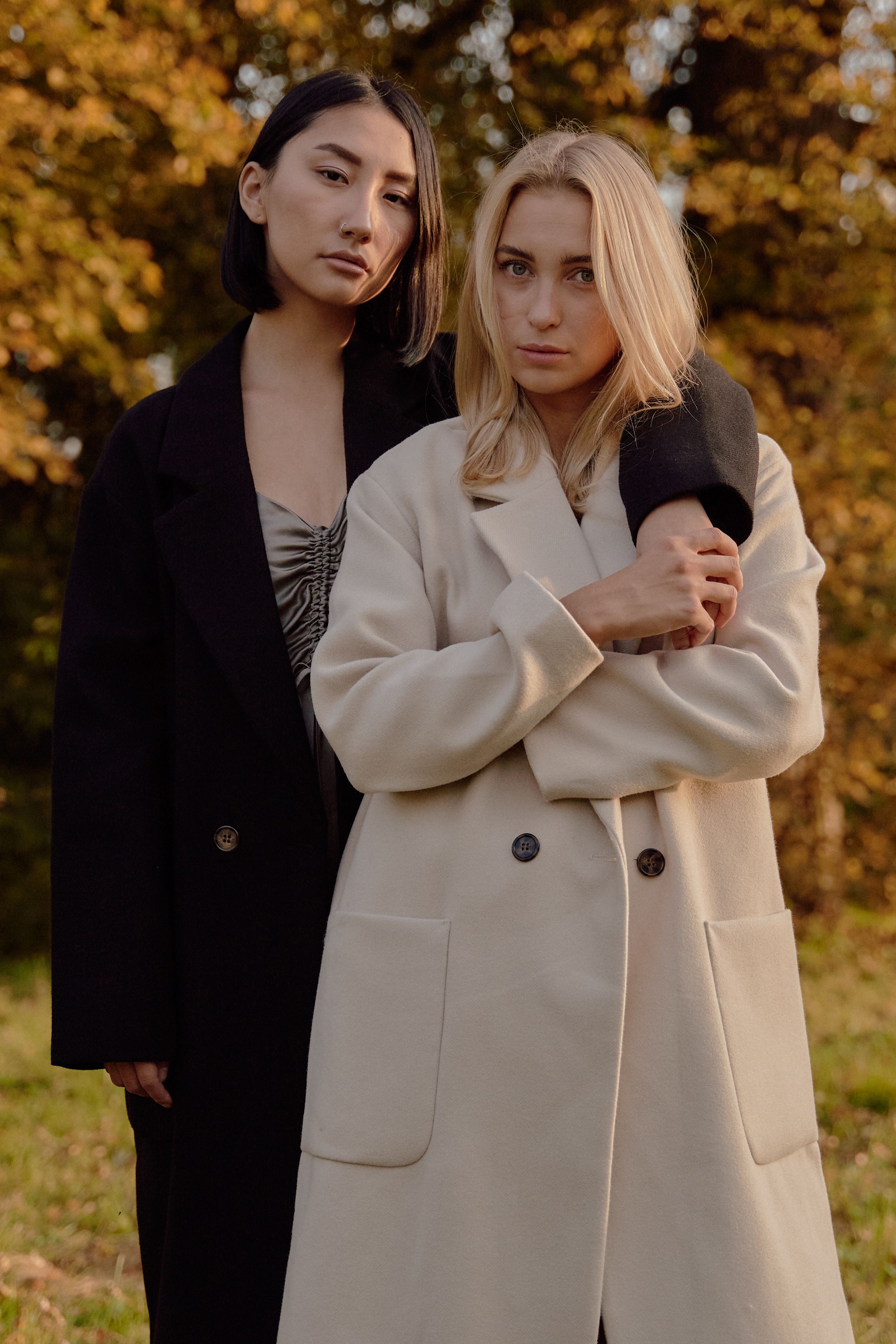 Women in Trench Coats Standing Together · Free Stock Photo
