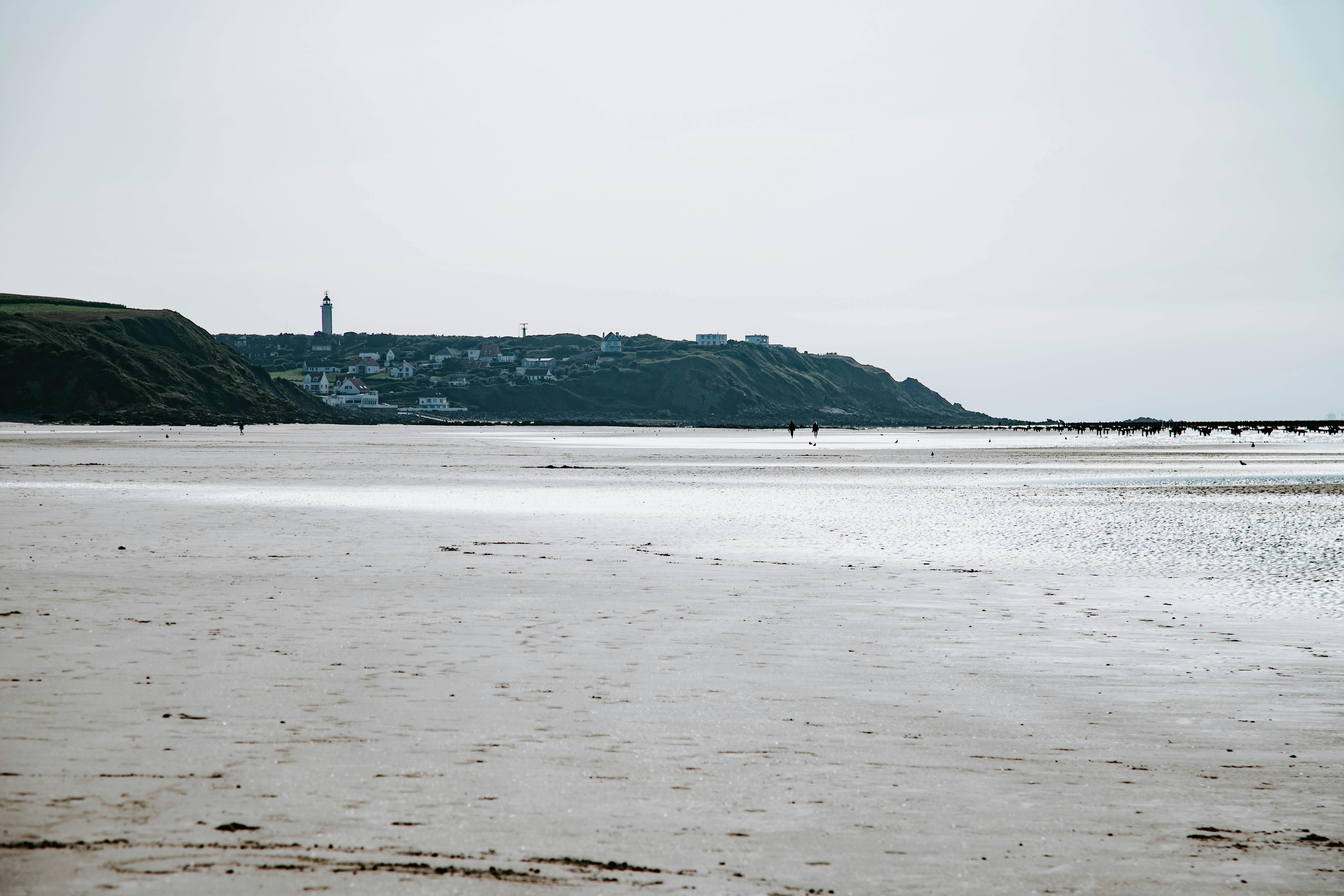Calm empty seashore with small town · Free Stock Photo