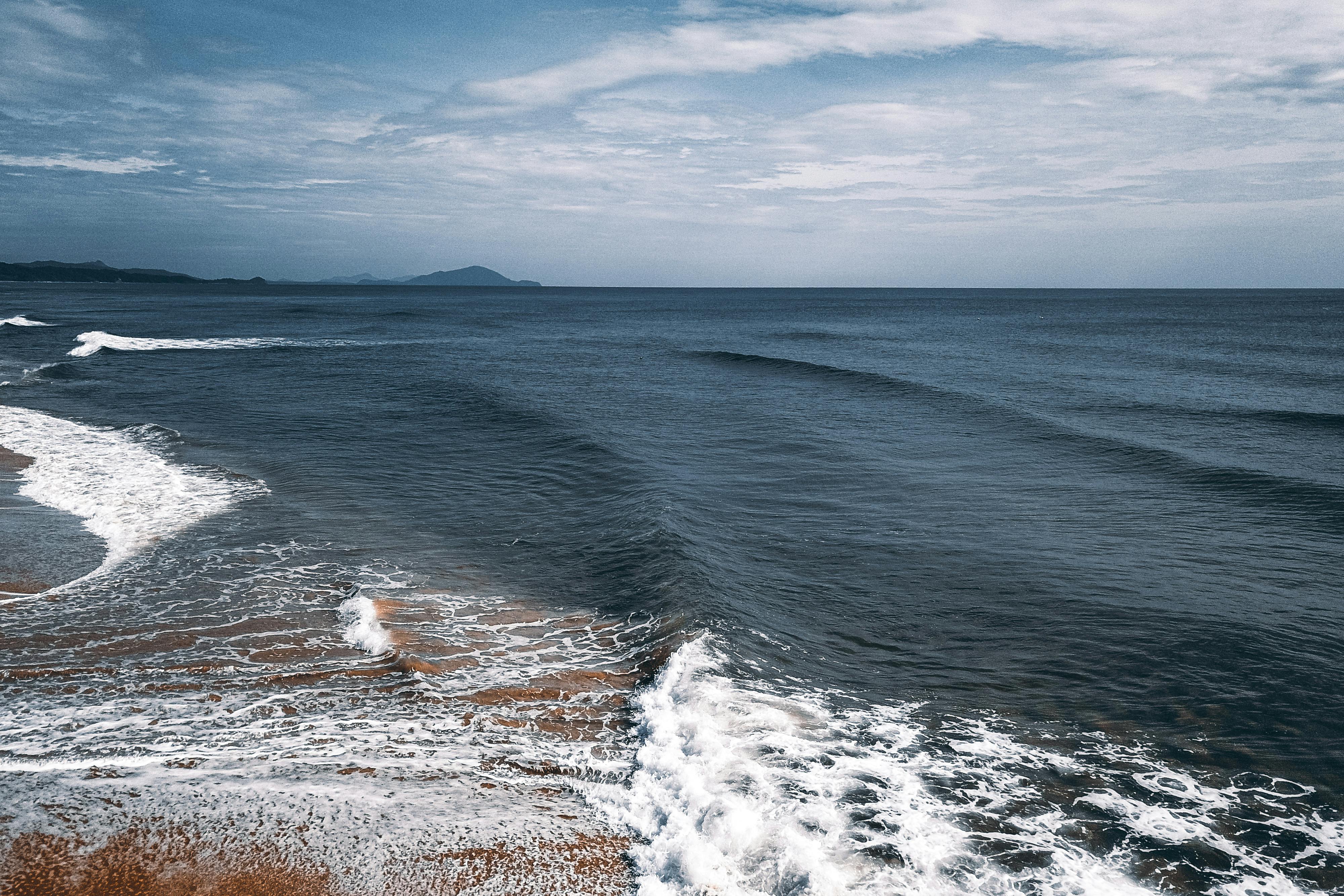 Stormy blue sea in sunlight · Free Stock Photo