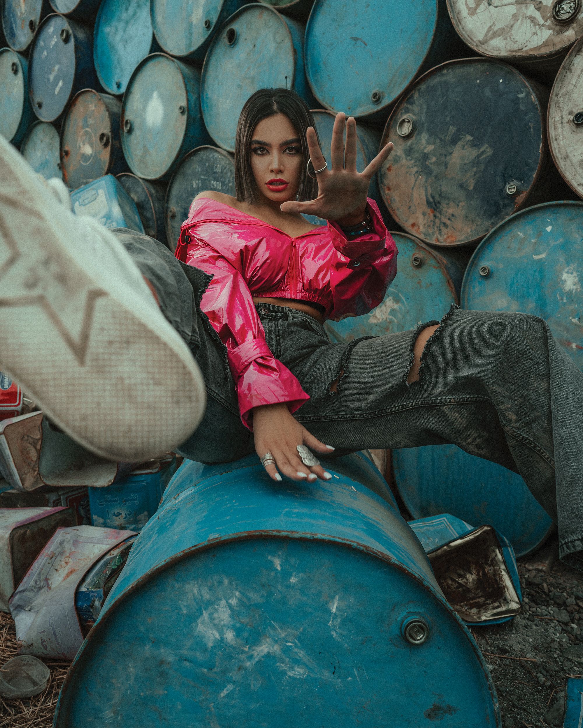 Ethnic woman in trendy clothes sitting on barrel · Free Stock Photo