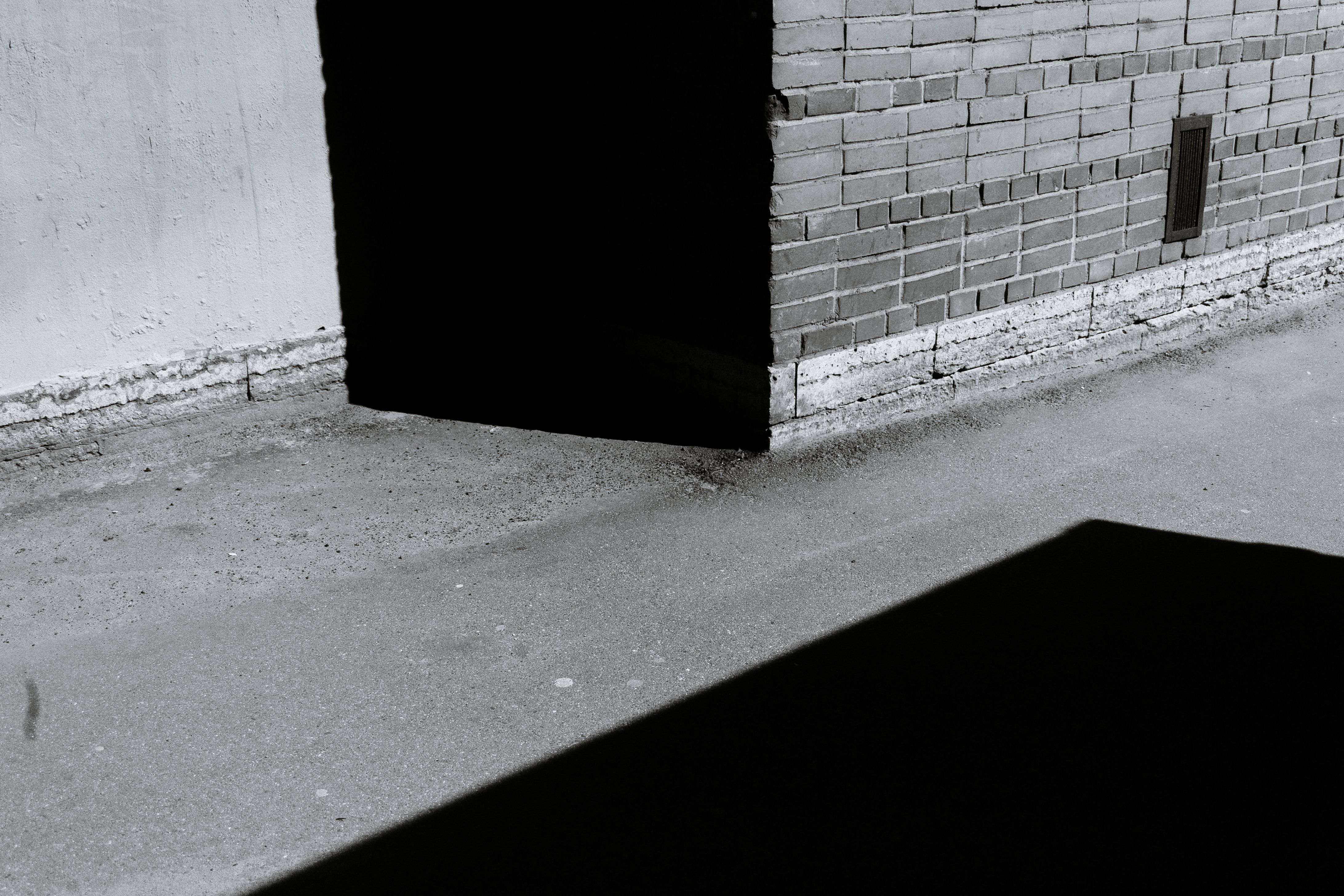 Dark brick wall outside modern building · Free Stock Photo