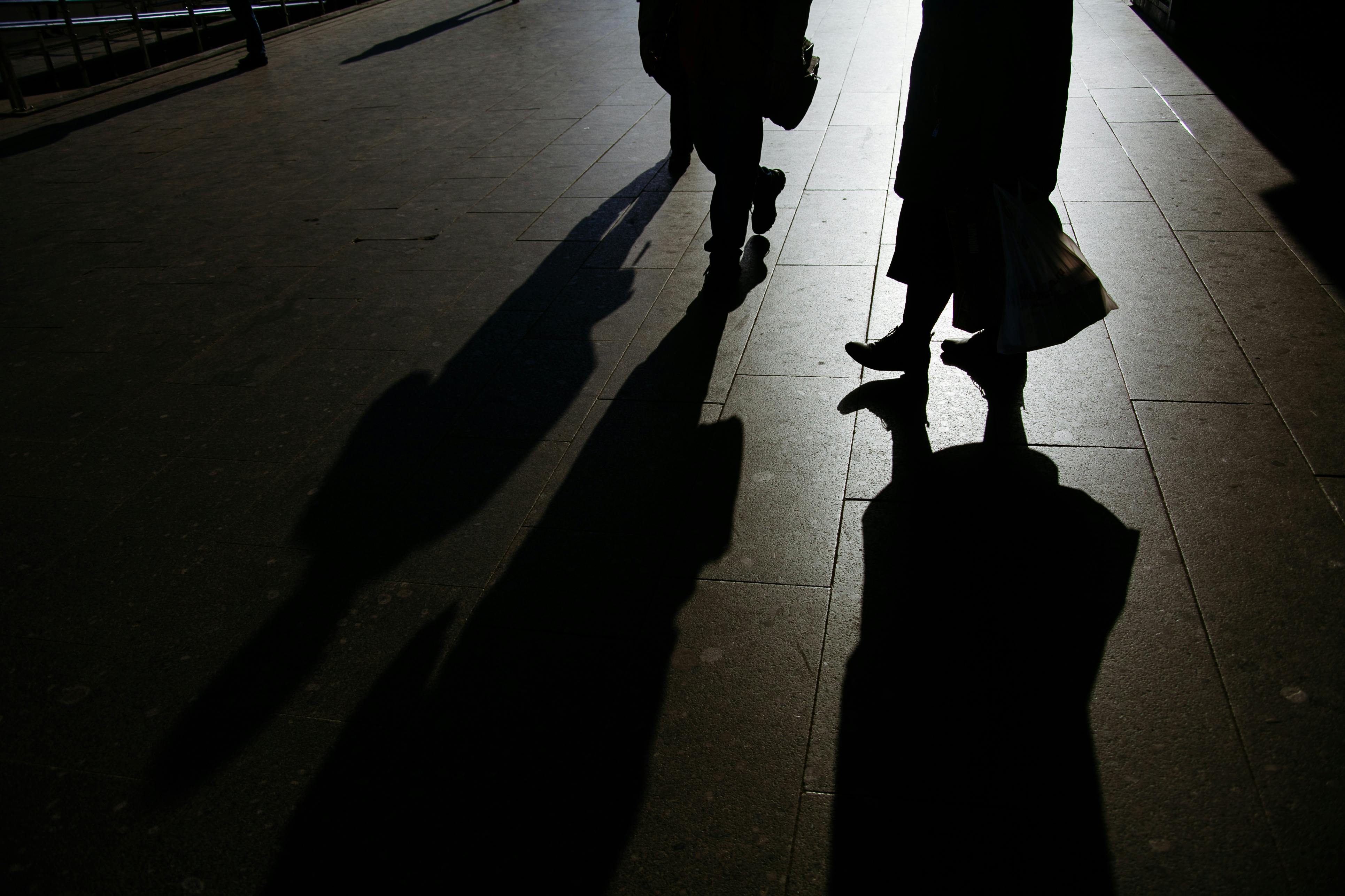 Anonymous pedestrians strolling on paved sidewalk at night · Free Stock ...