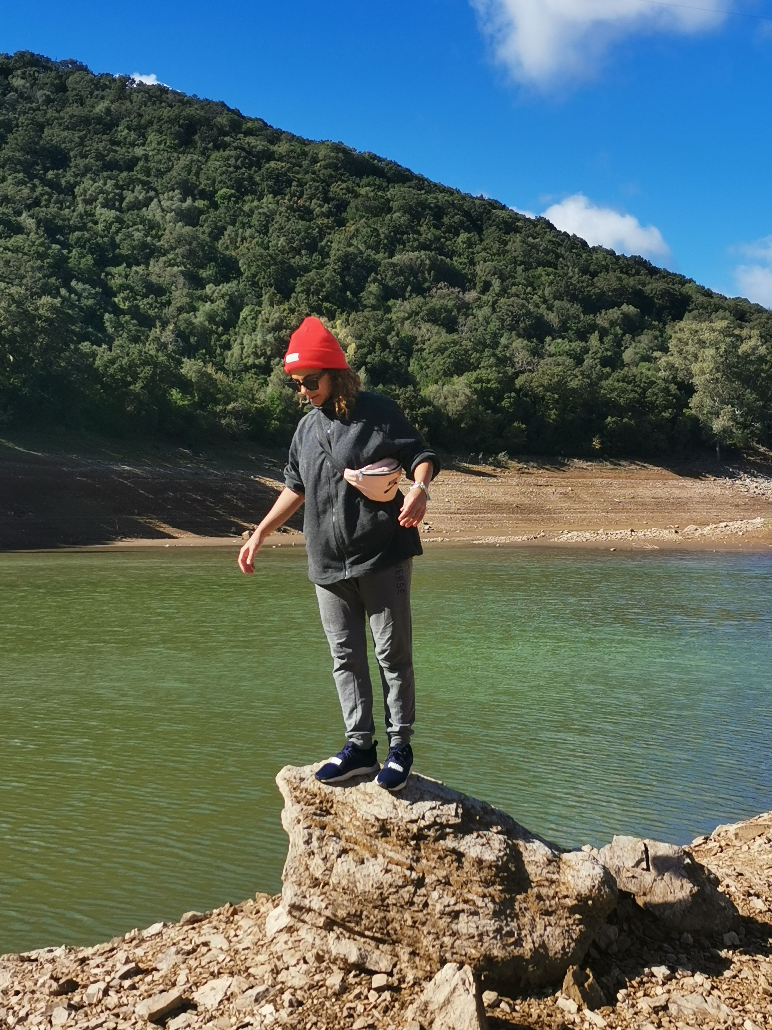 Person Standing on a Brown Wood Log Floating on a Body of Water · Free ...