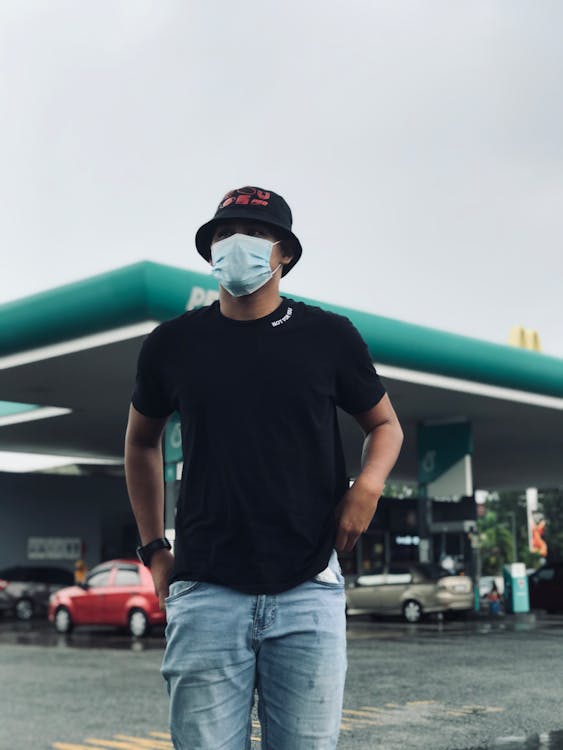 Man In Black Crew Neck T Shirt Wearing A Bucket Hat And Facemask · Free