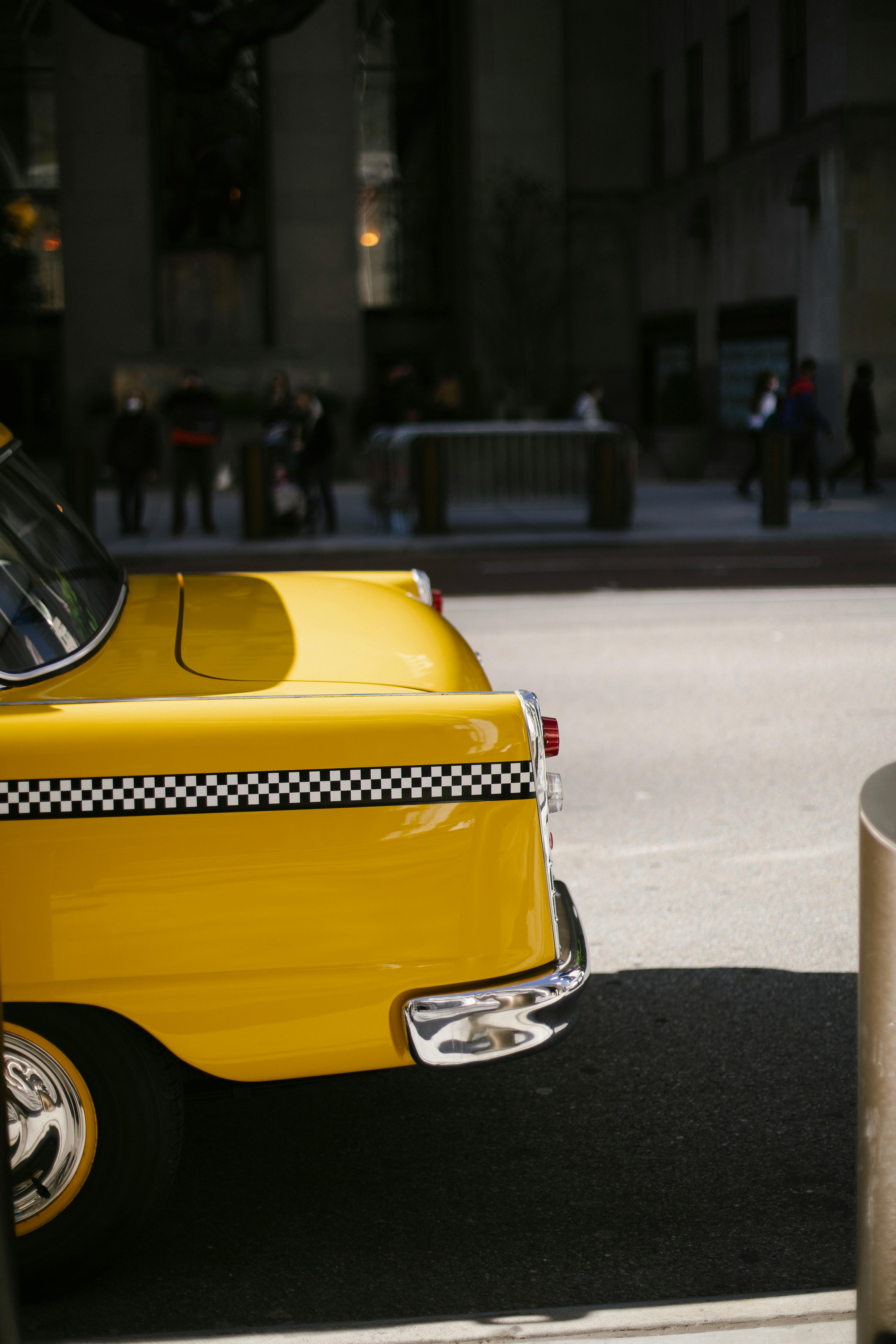 Classic yellow cab on asphalt road · Free Stock Photo