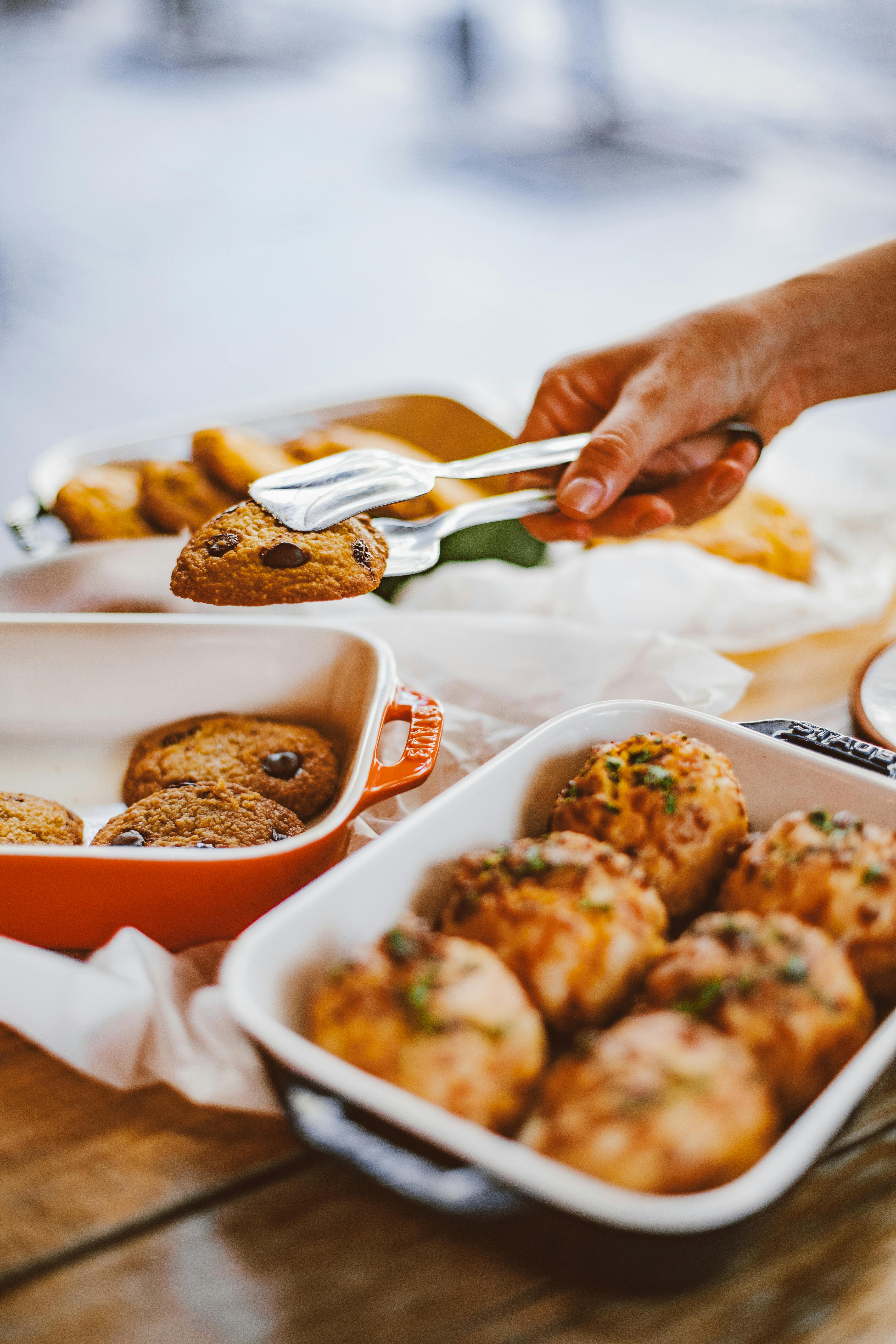 Picking Cookies with a Tong · Free Stock Photo