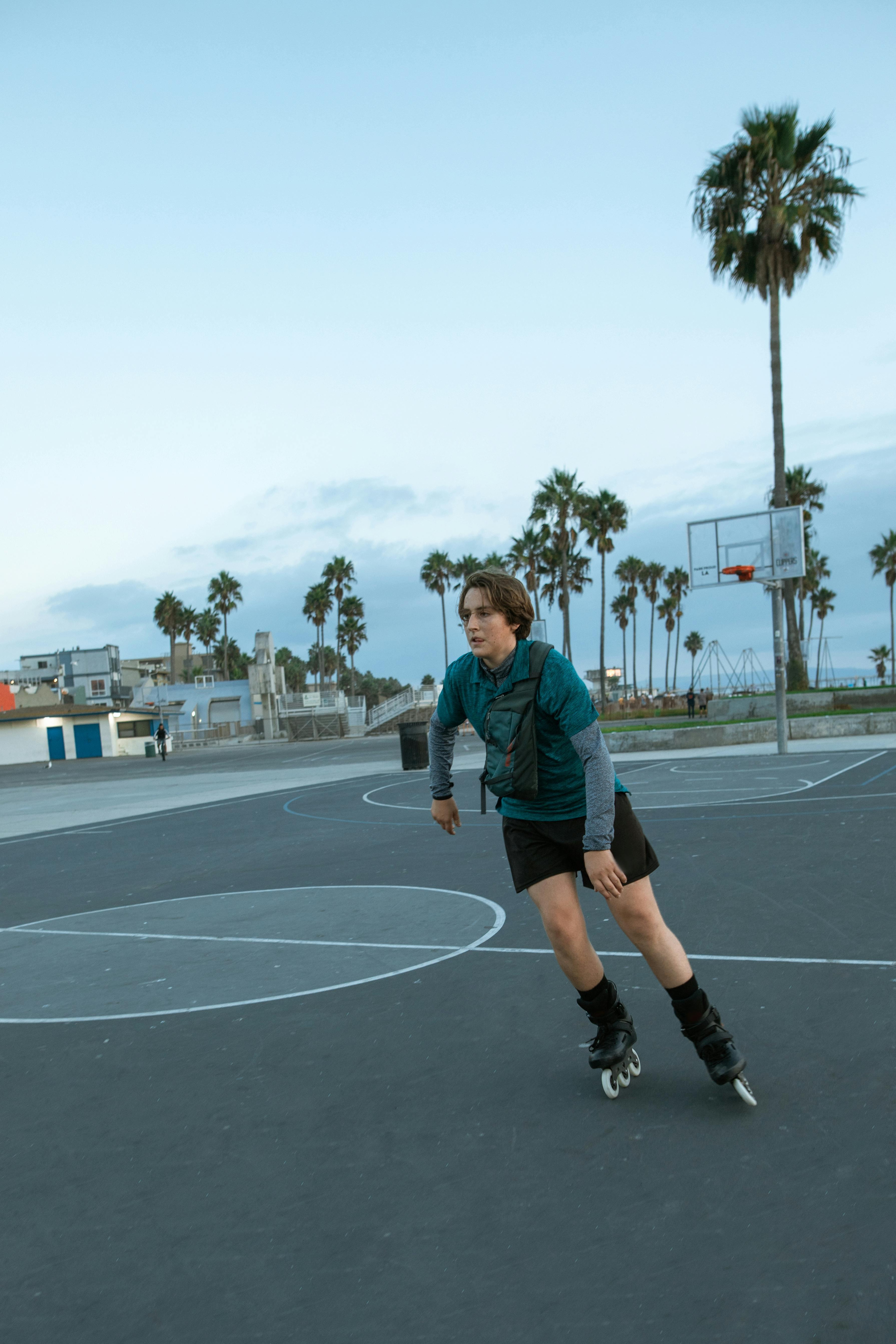 A Young Man Rollerblading in a Basketball Court · Free Stock Photo