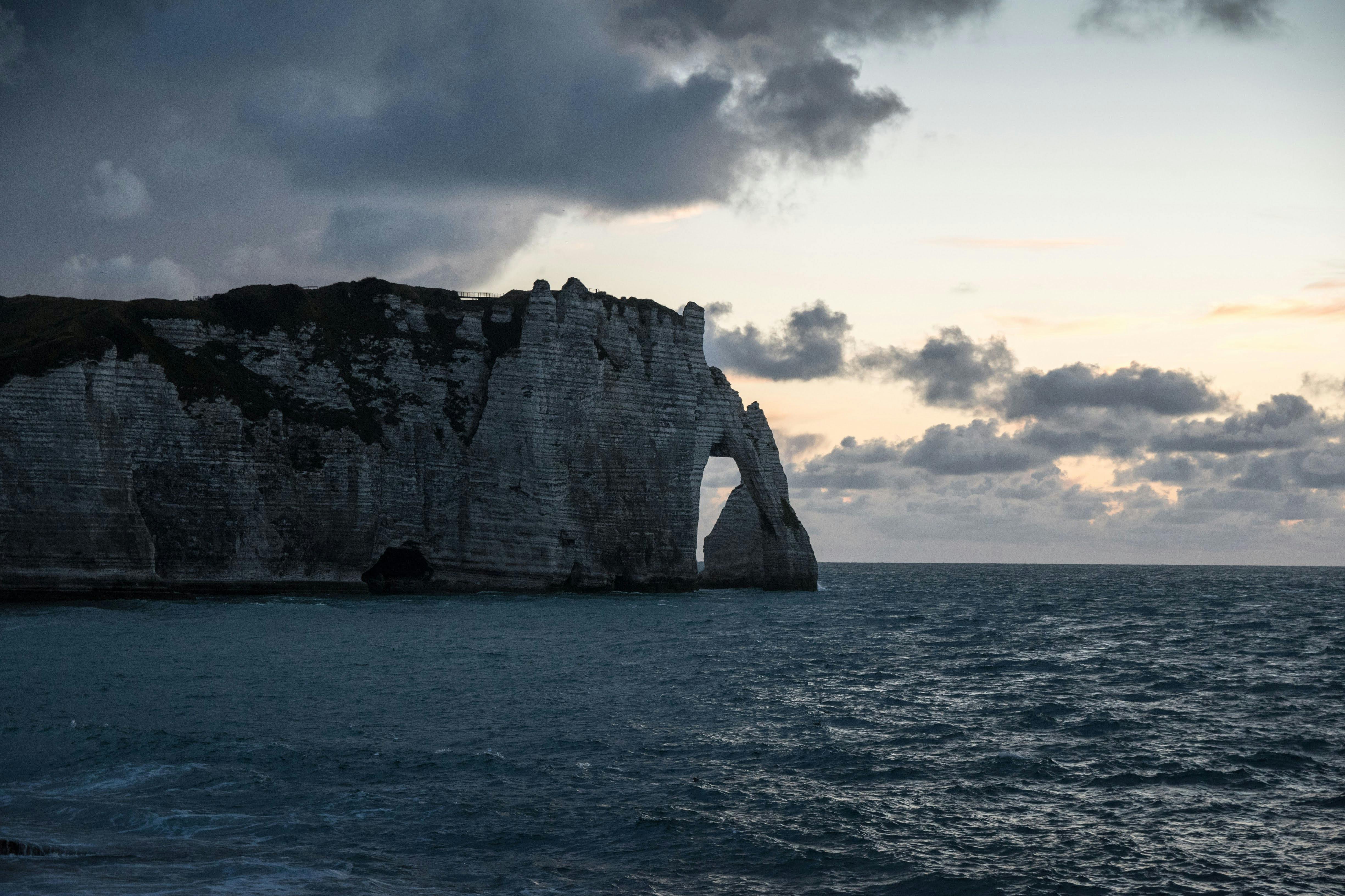 Photo of a Cliff with a Cave · Free Stock Photo