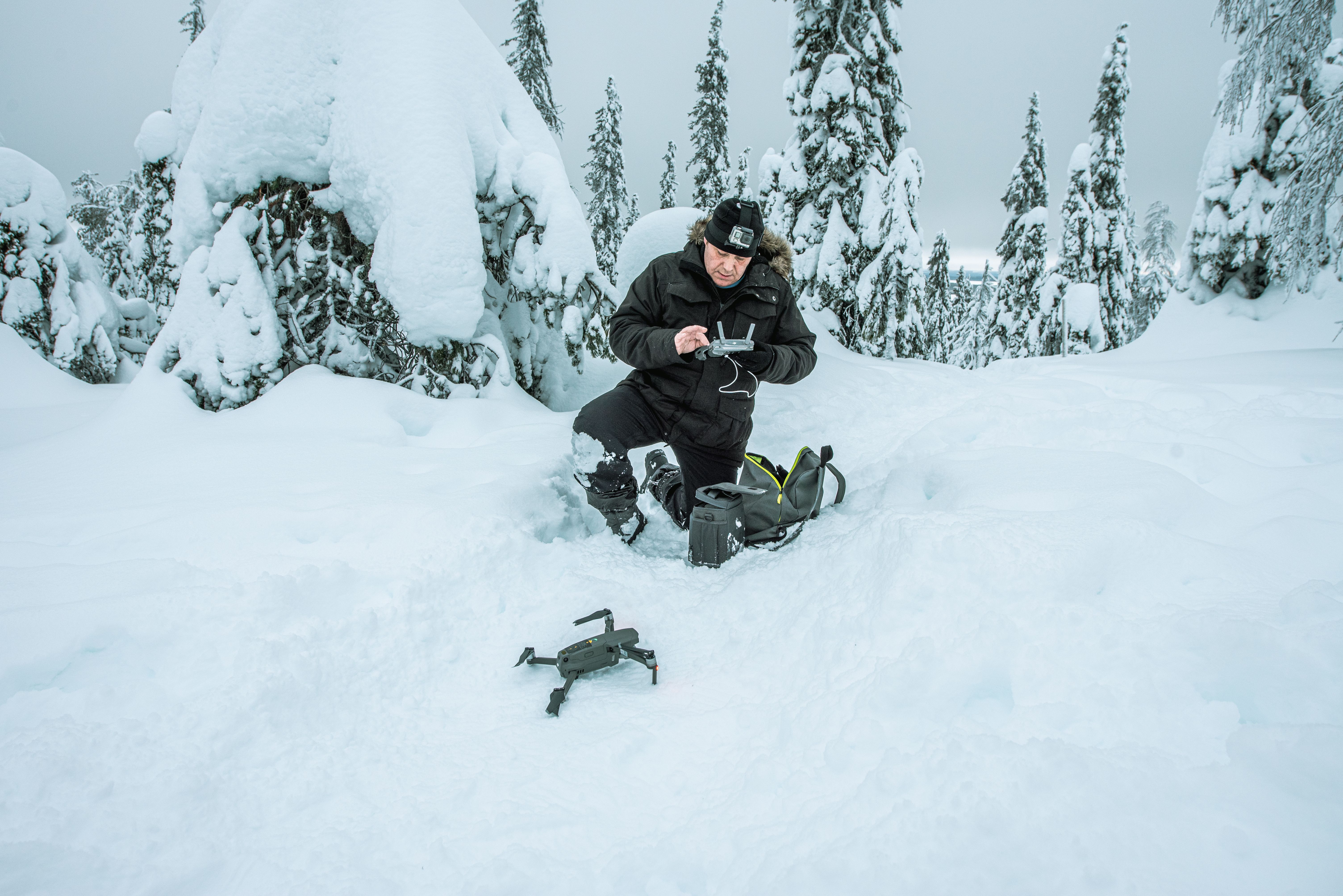A Man Setting Up a Drone Camera on the Snow · Free Stock Photo