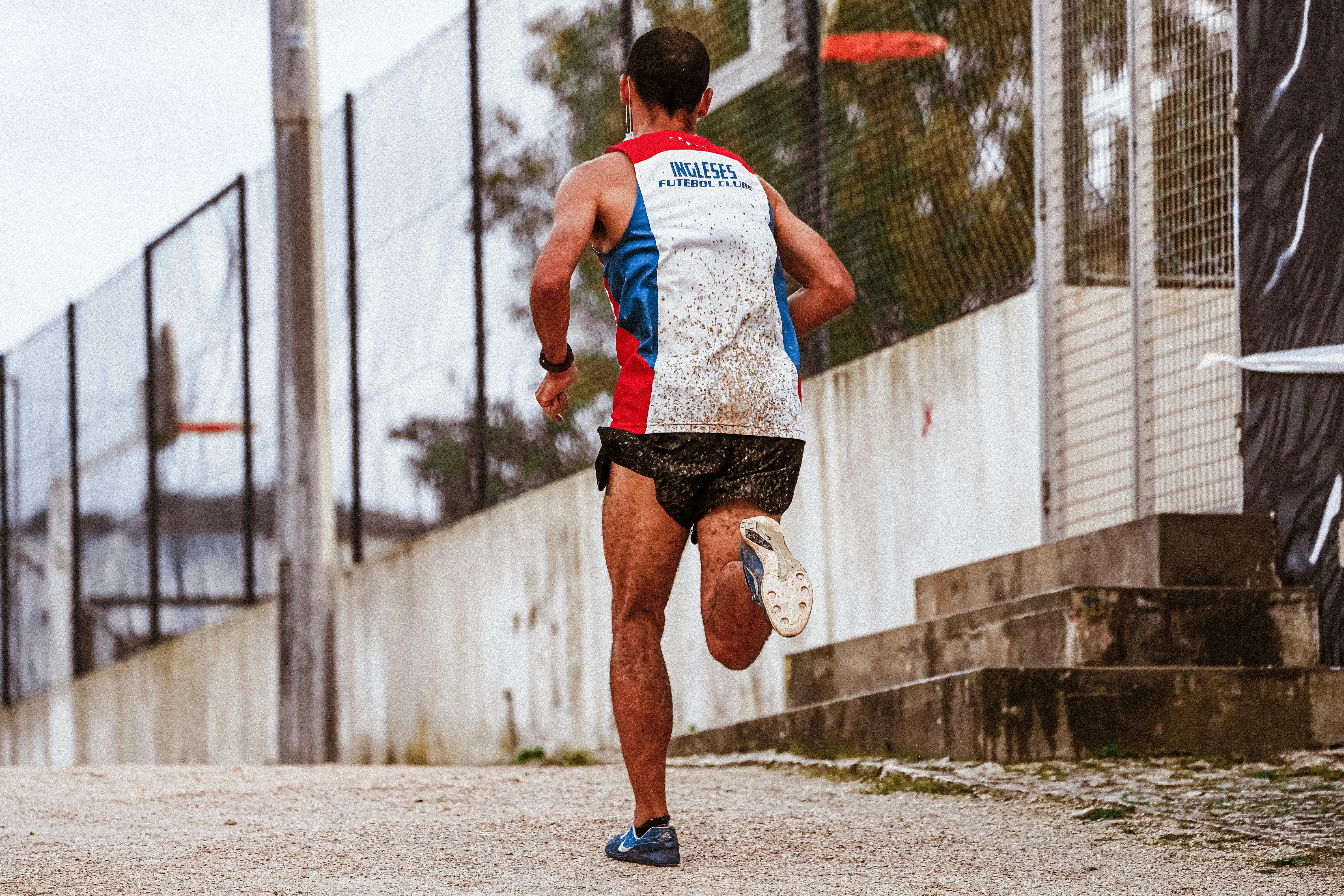 Man Running on Concrete Road · Free Stock Photo