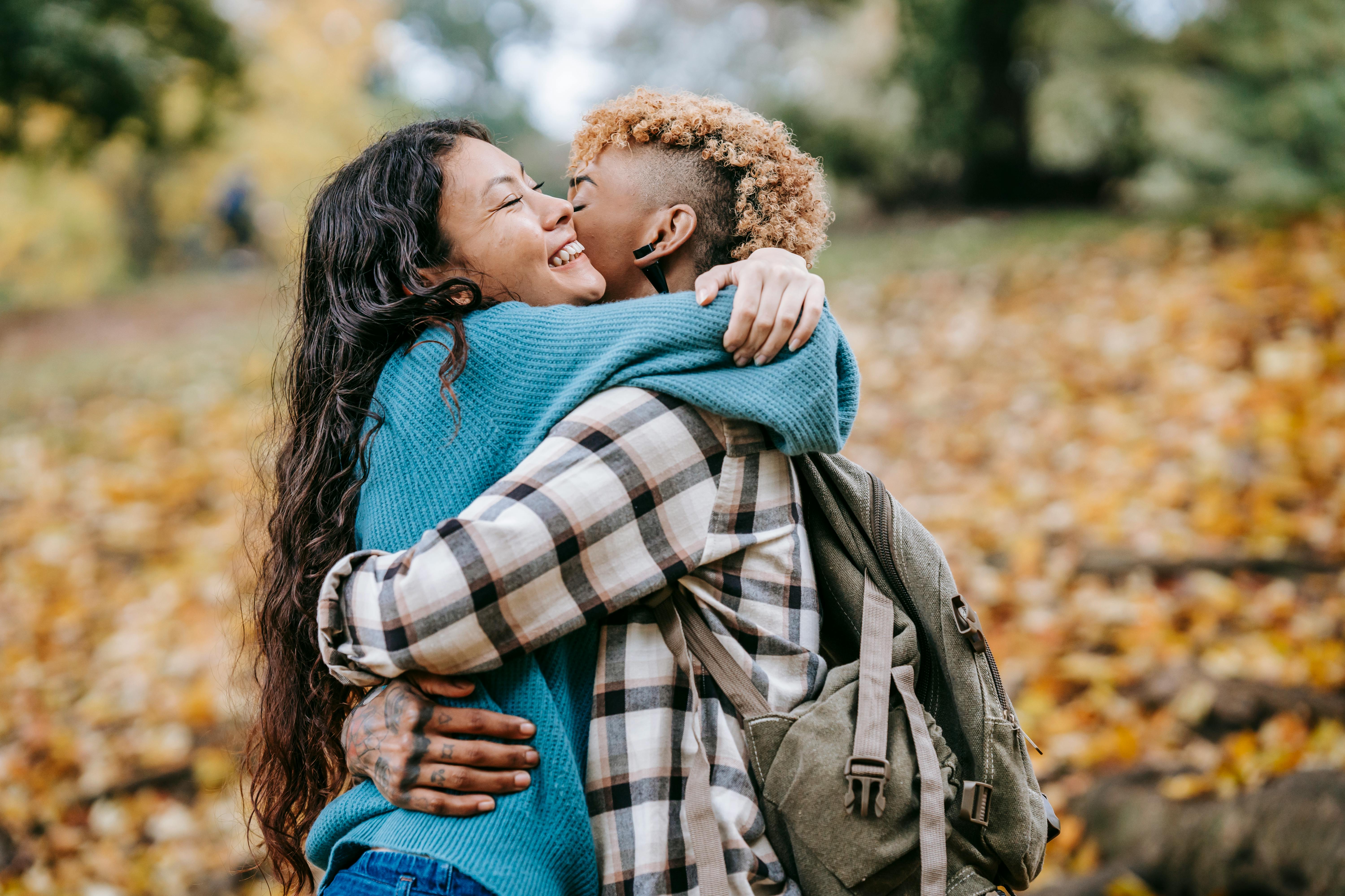 Loving unrecognizable black couple hugging on illuminated street · Free ...