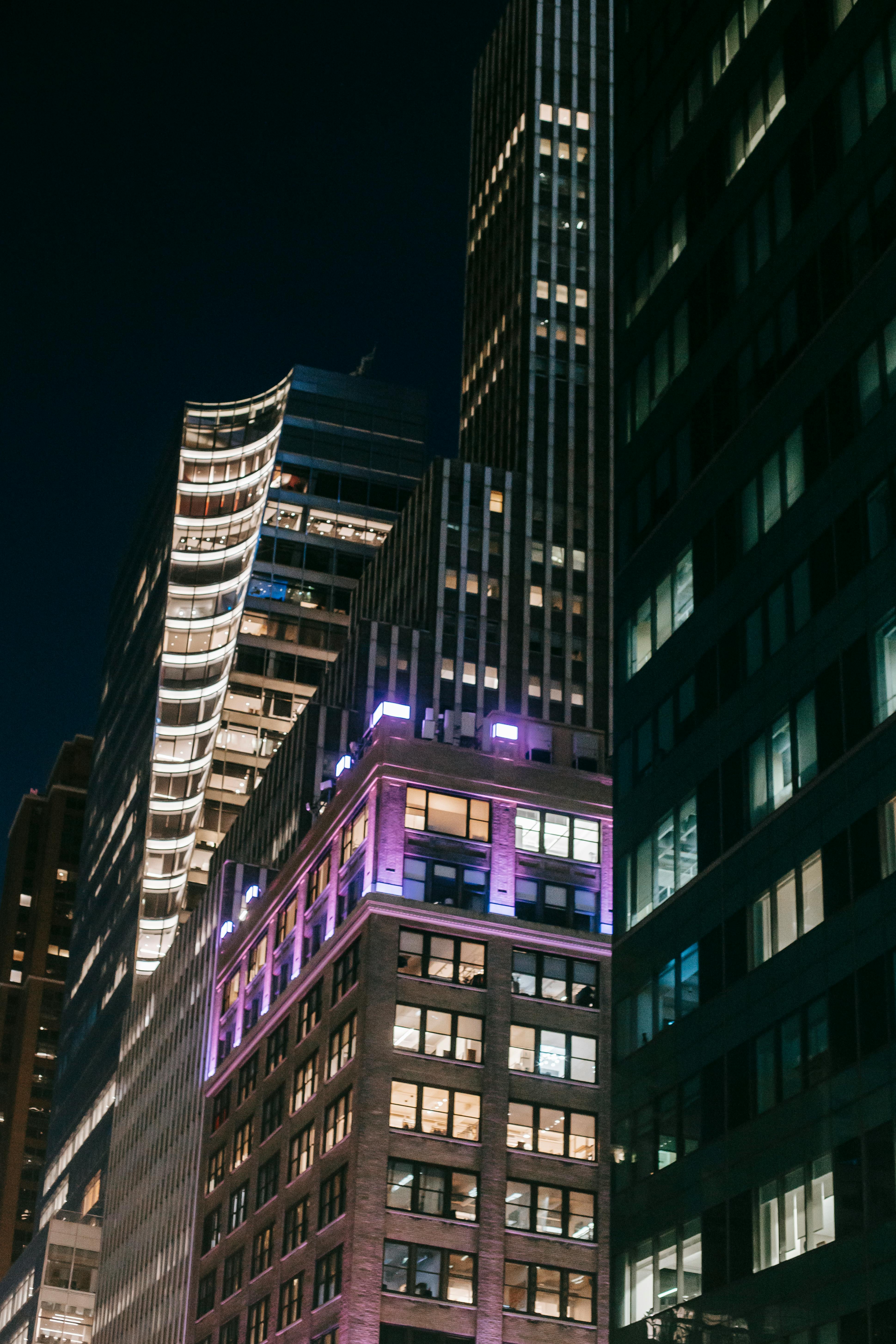 Modern skyscrapers with lights at night in United States · Free Stock Photo
