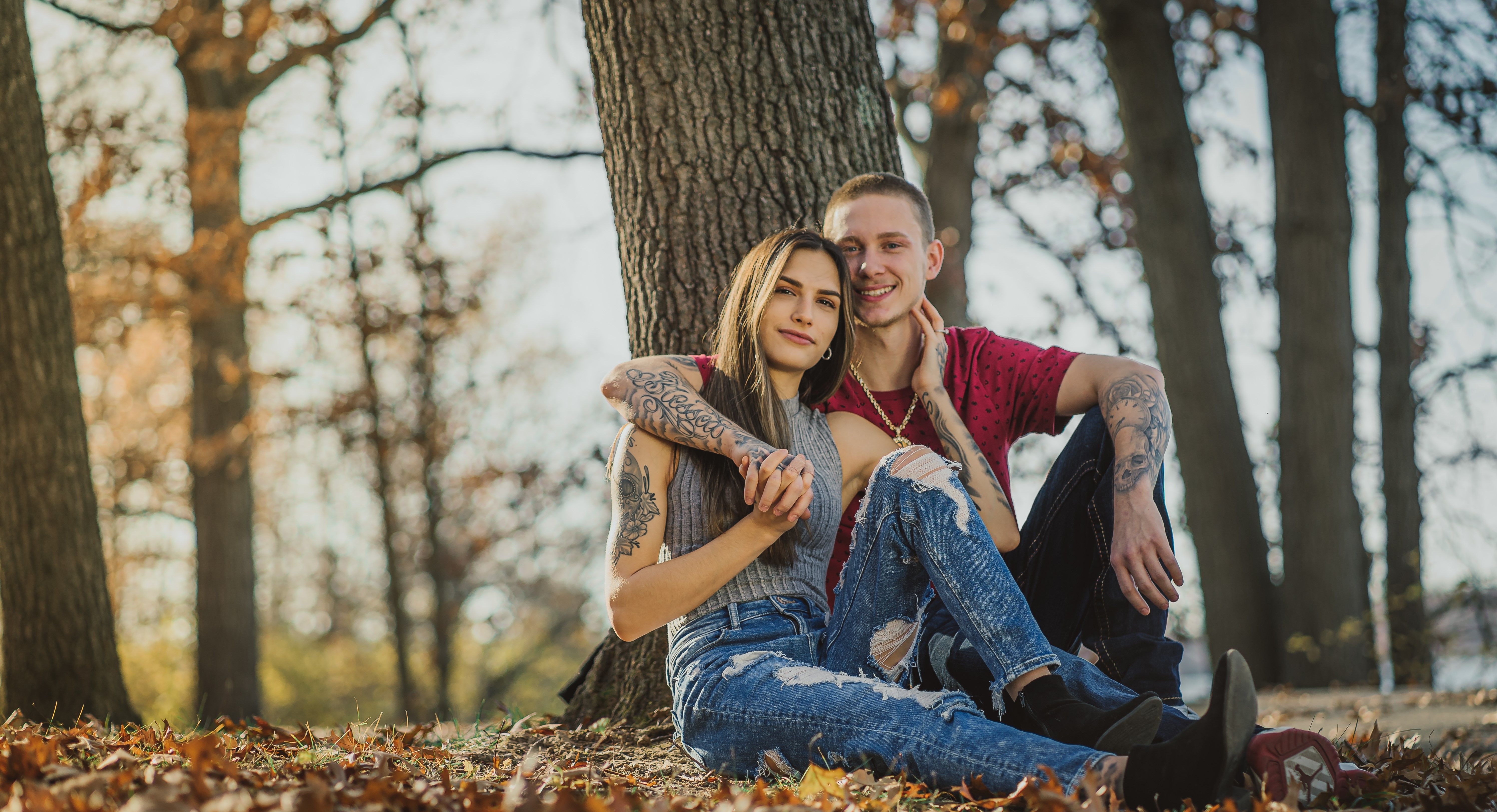 A Man Sitting on a Log in a Forest · Free Stock Photo
