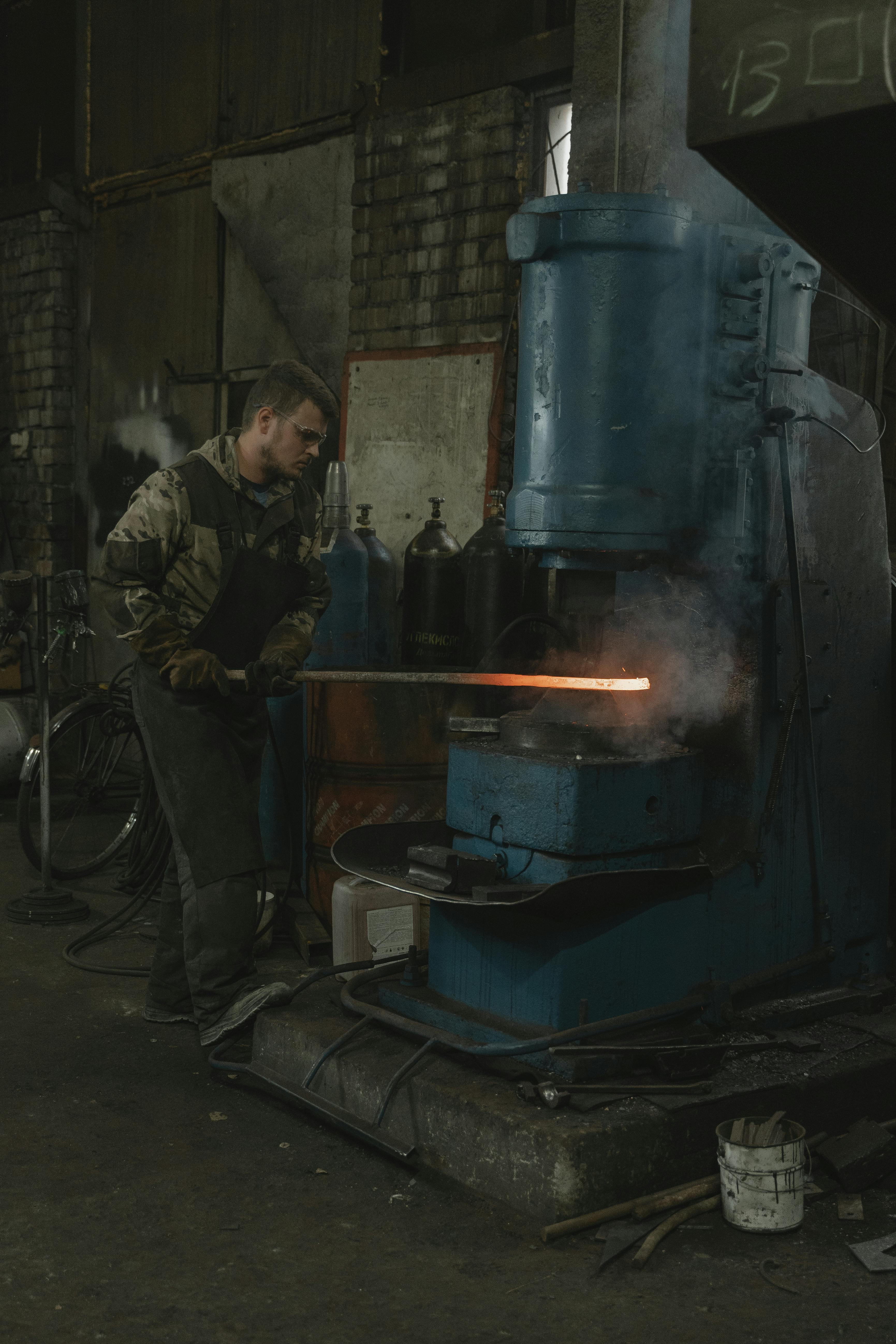 Man Forging Metal using a Machine · Free Stock Photo