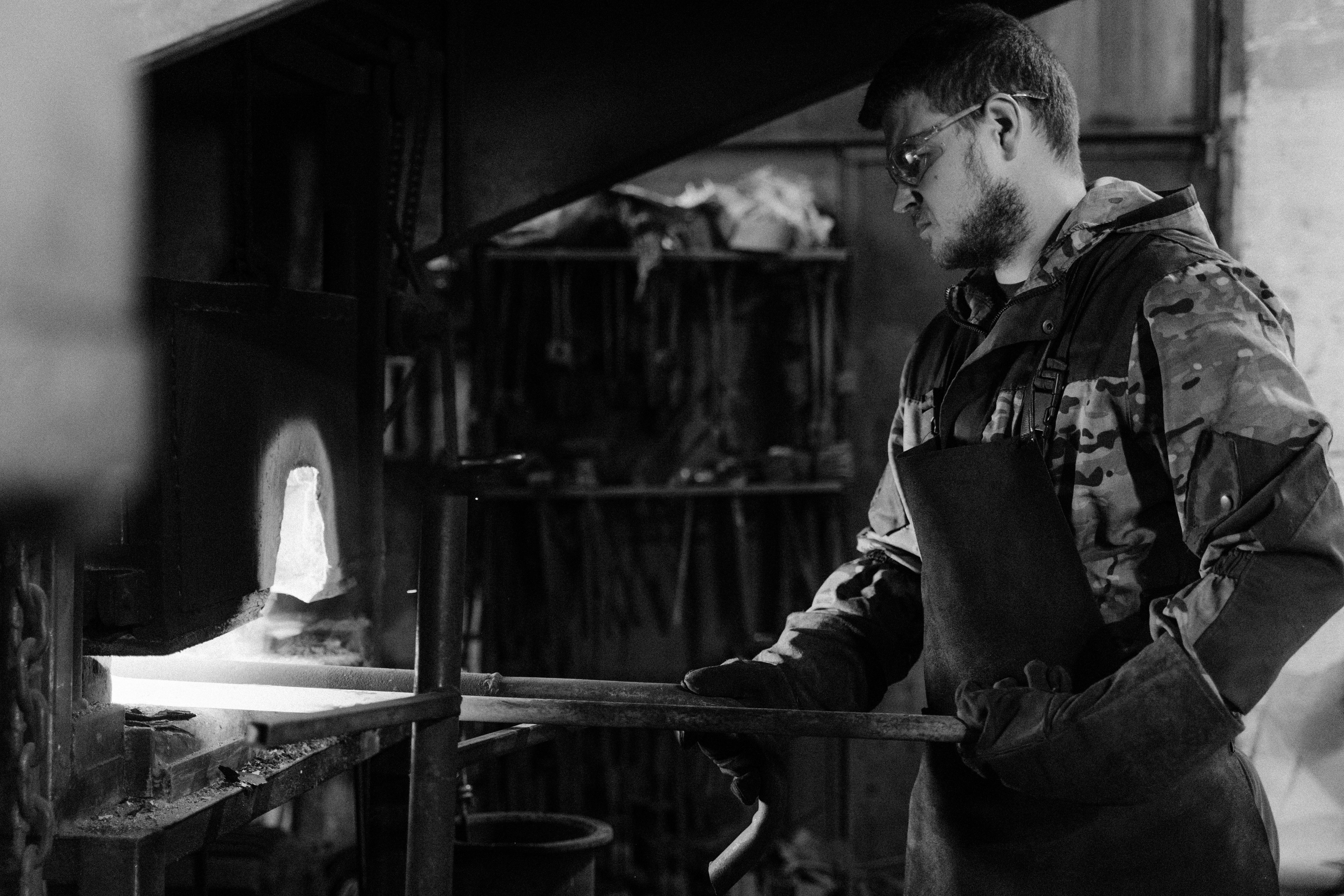 Grayscale Photo of Man Forging Steel Bar · Free Stock Photo