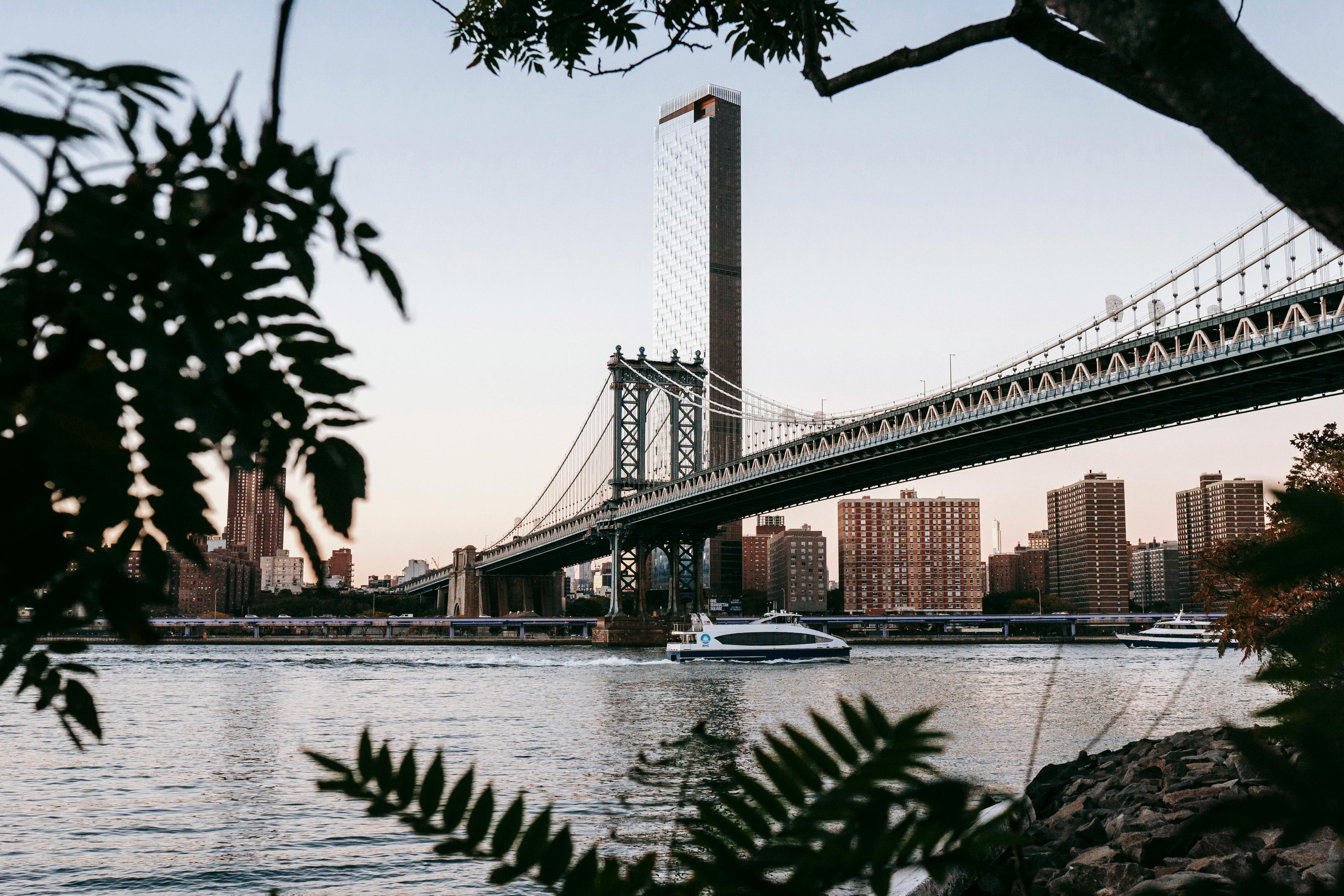 Suspension bridge over river in city · Free Stock Photo