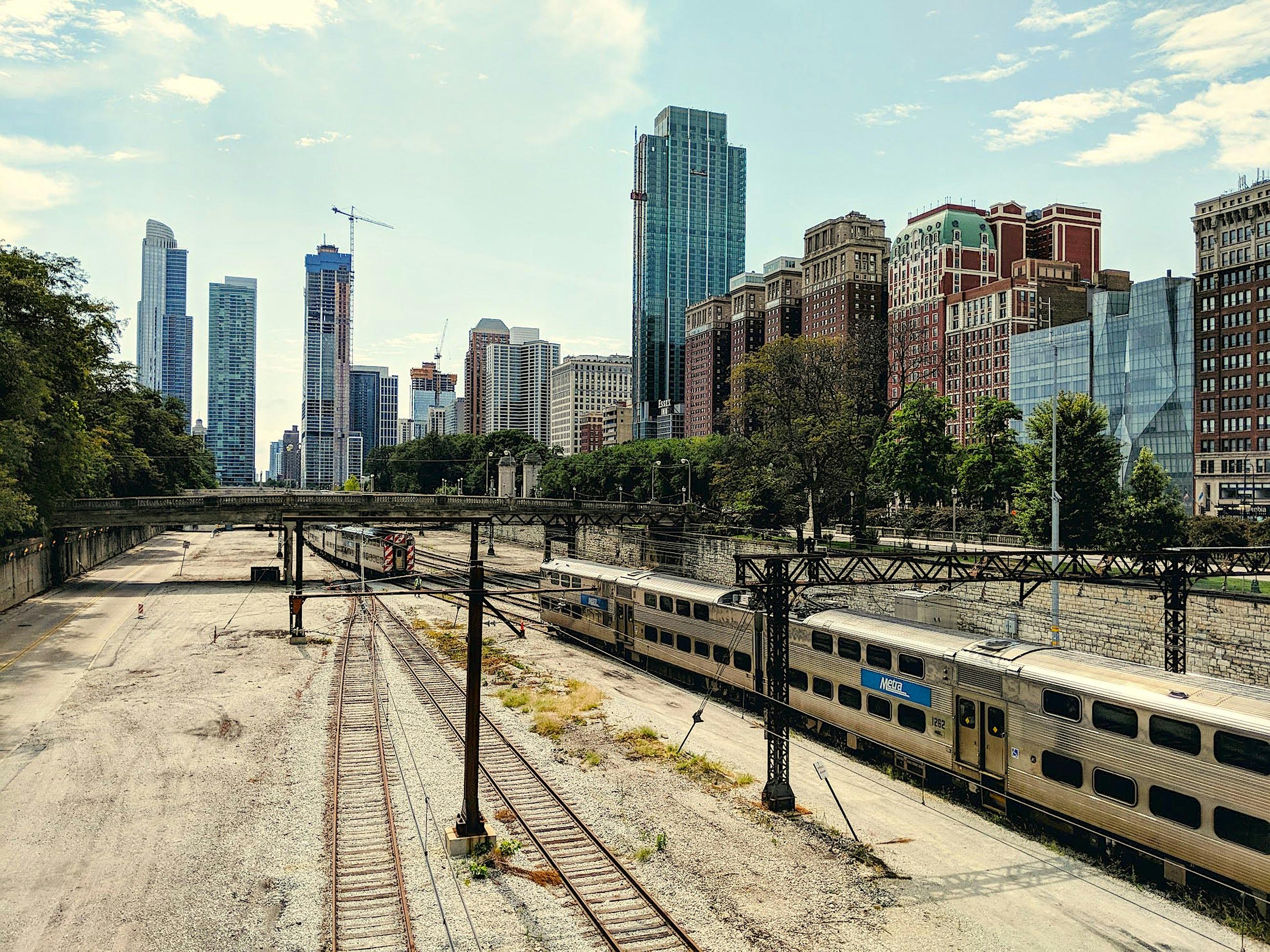 A Monorail Train Between High Rise Buildings · Free Stock Photo
