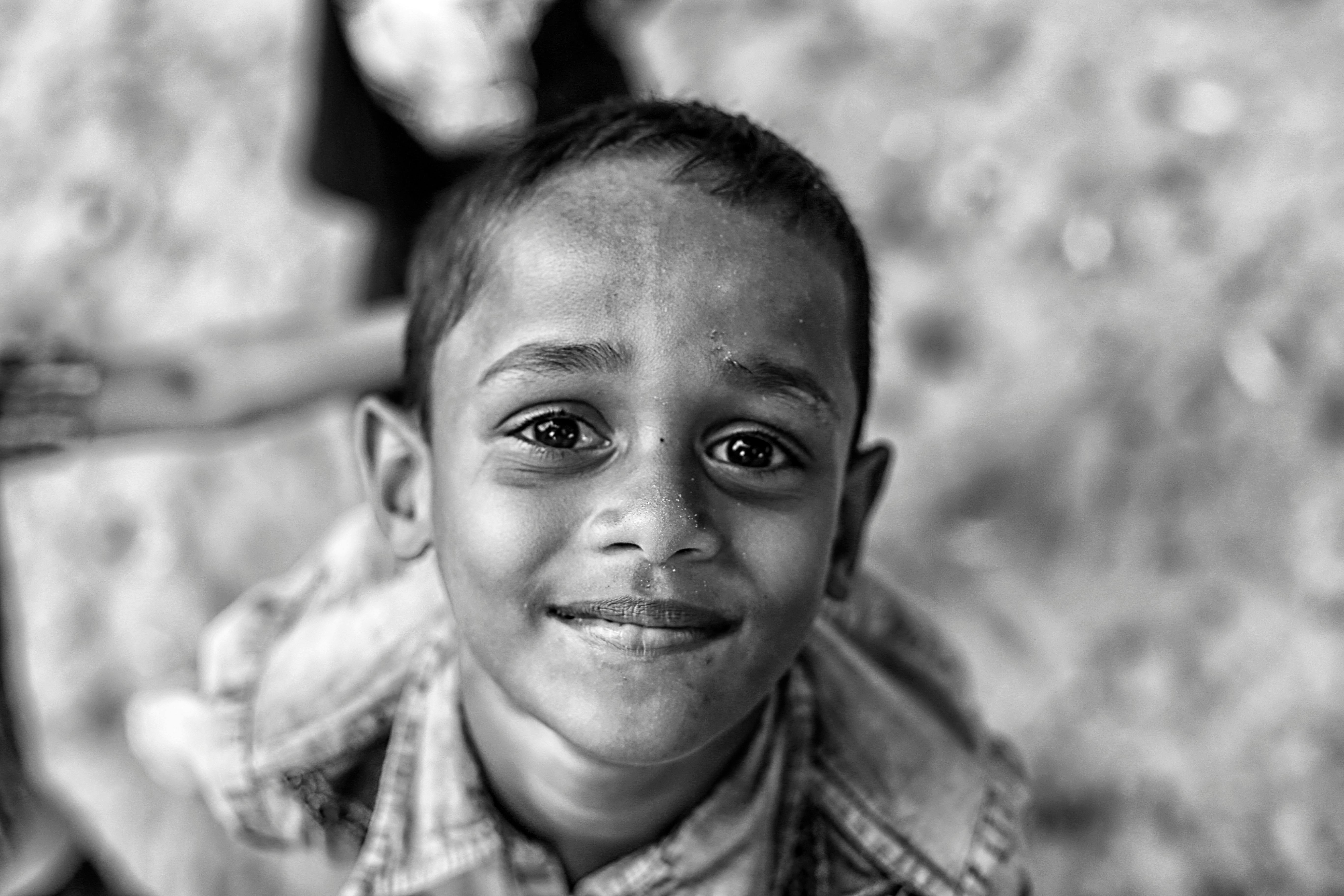 Grayscale Photo of a Child Smiling · Free Stock Photo