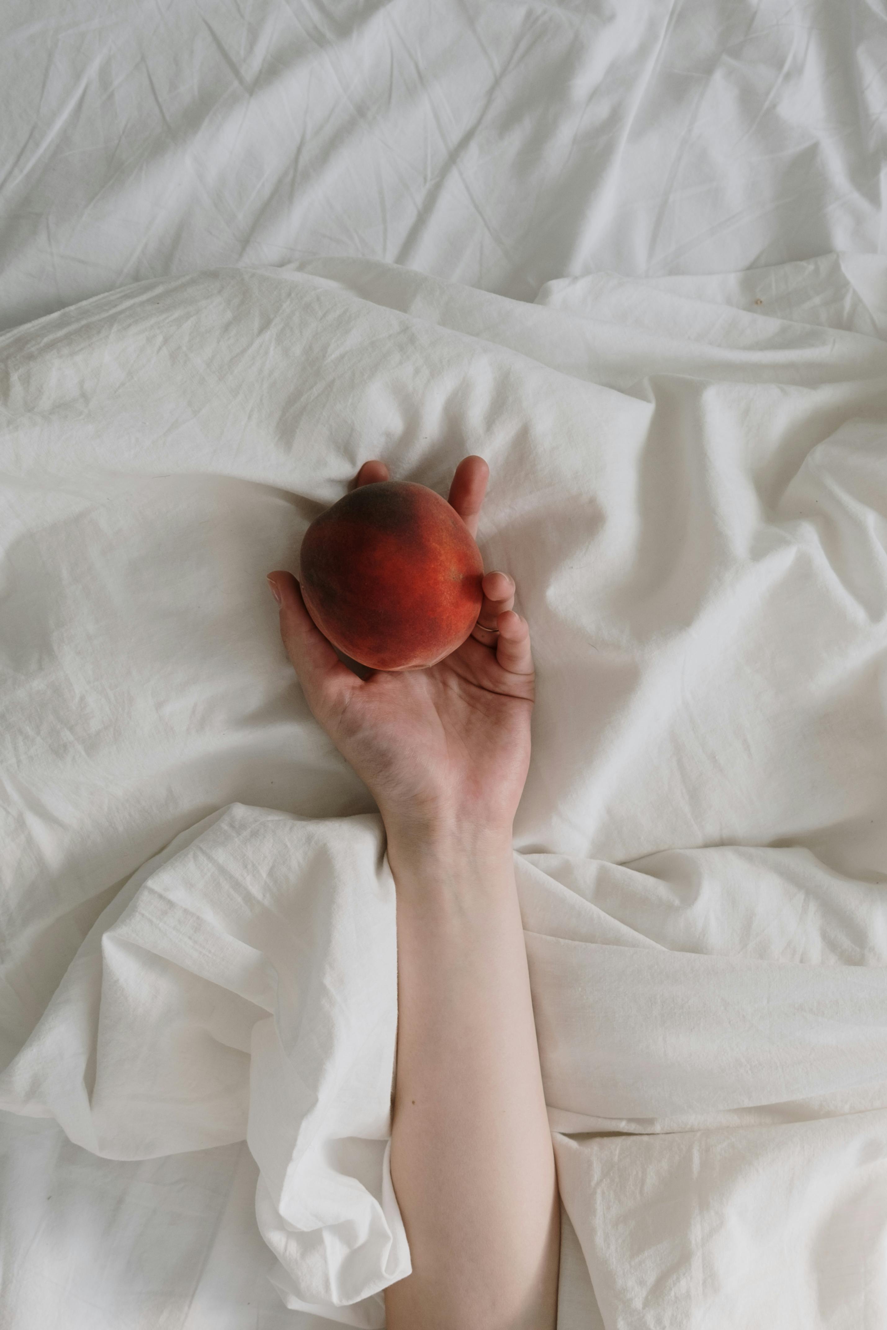 A Person Holding a Peach · Free Stock Photo