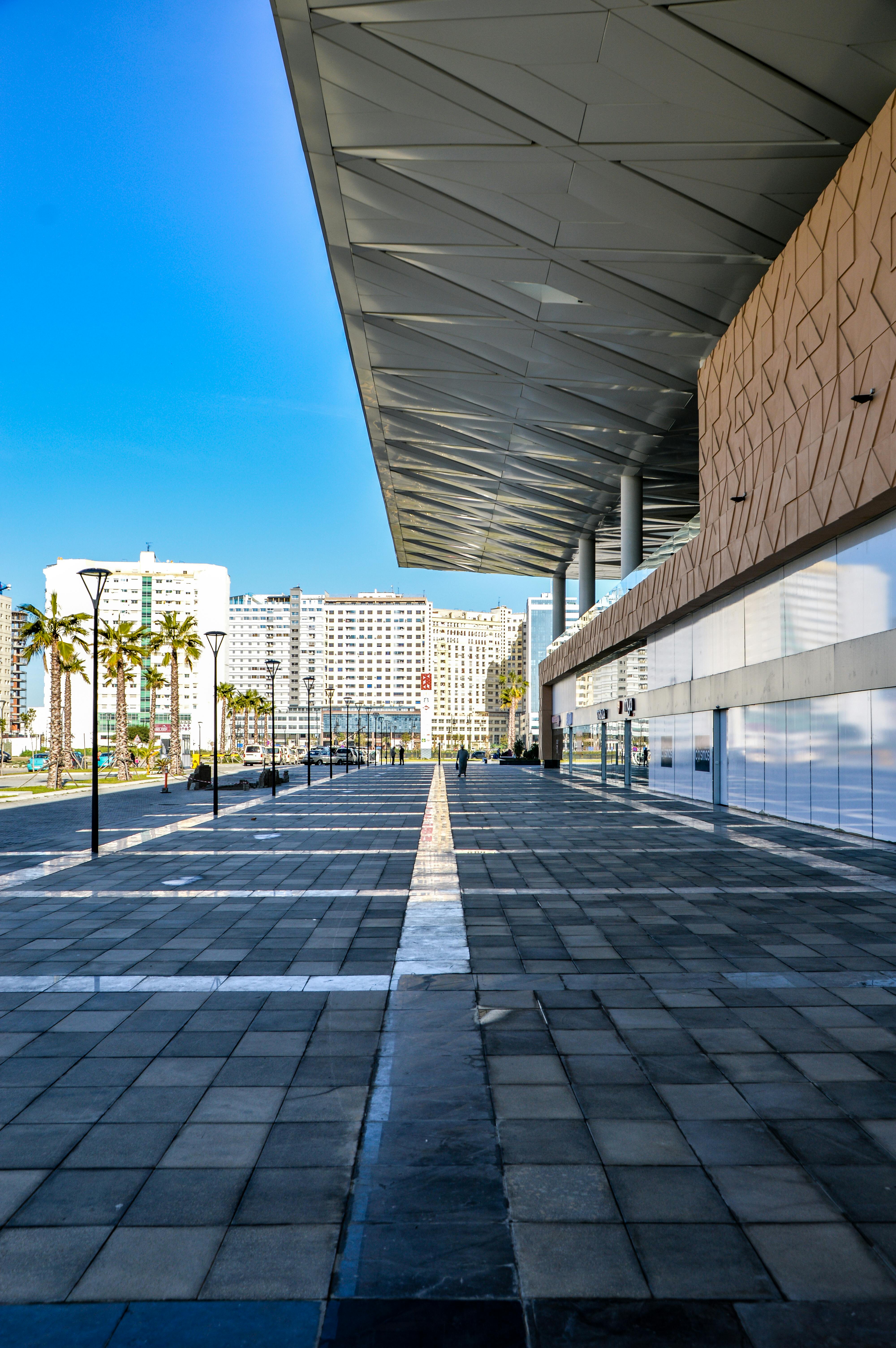 Paved Sidewalk Near Building With Glass Windows · Free Stock Photo