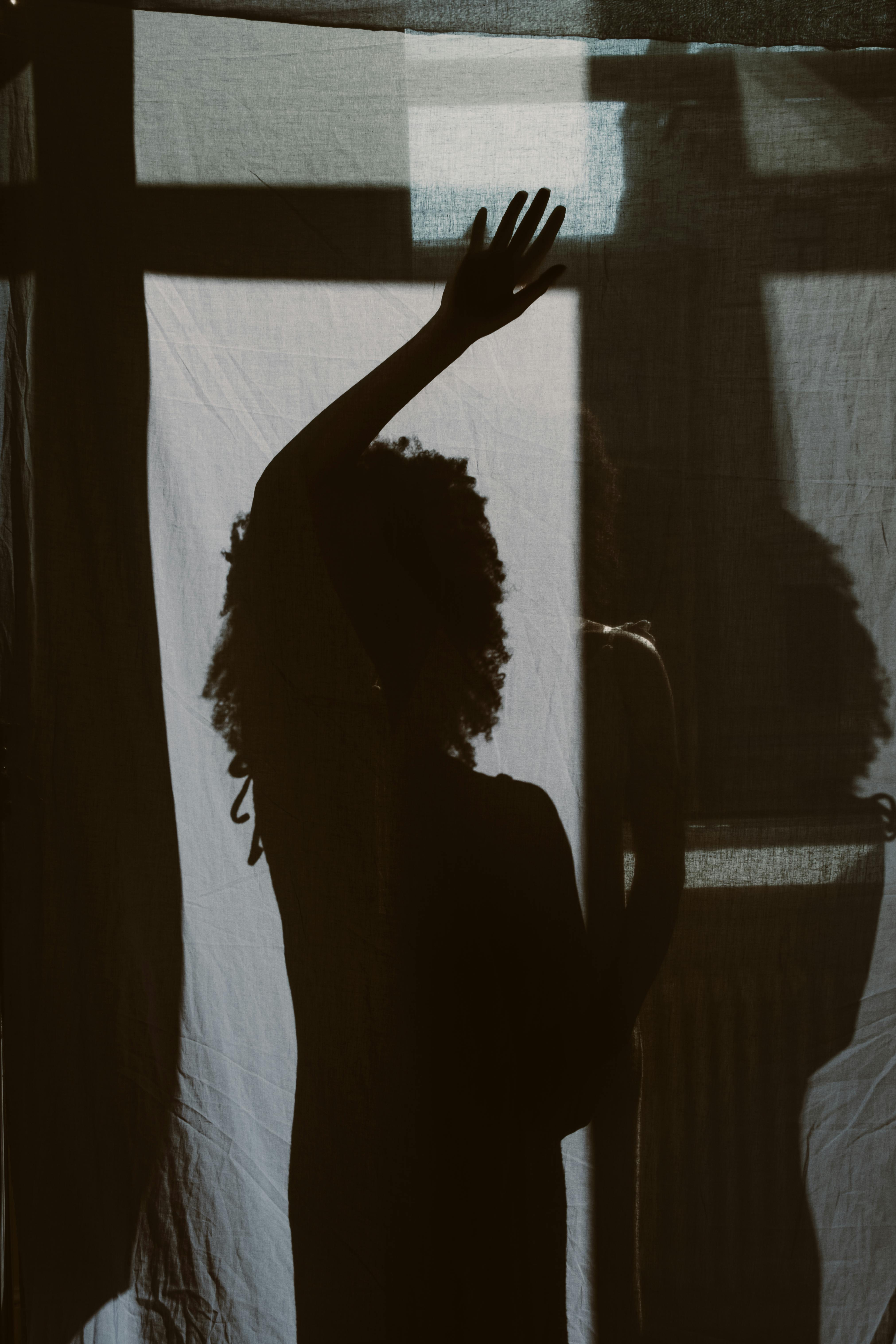 Human Hand Behind Brown Curtain · Free Stock Photo