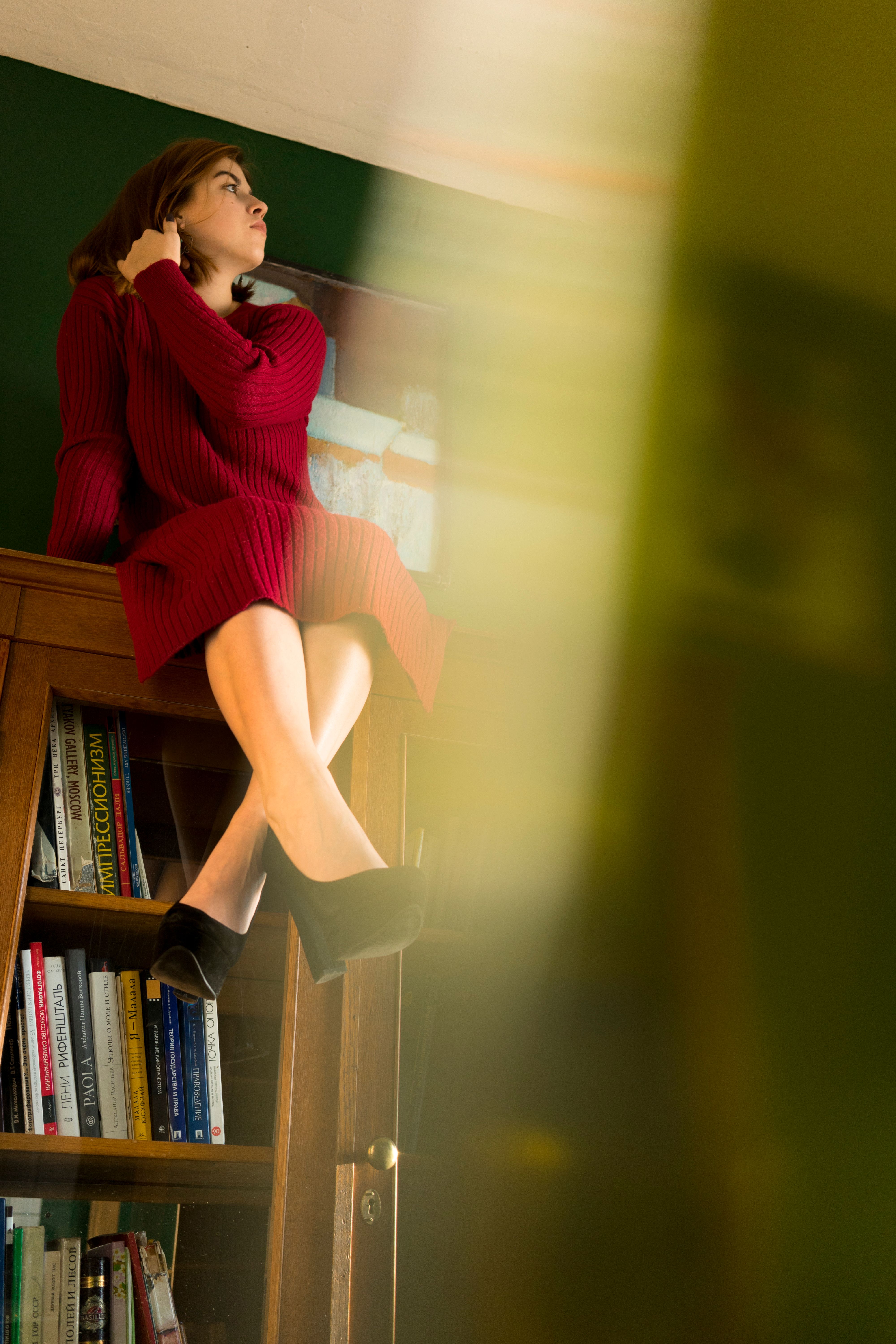 Woman on bookcase in vintage room · Free Stock Photo